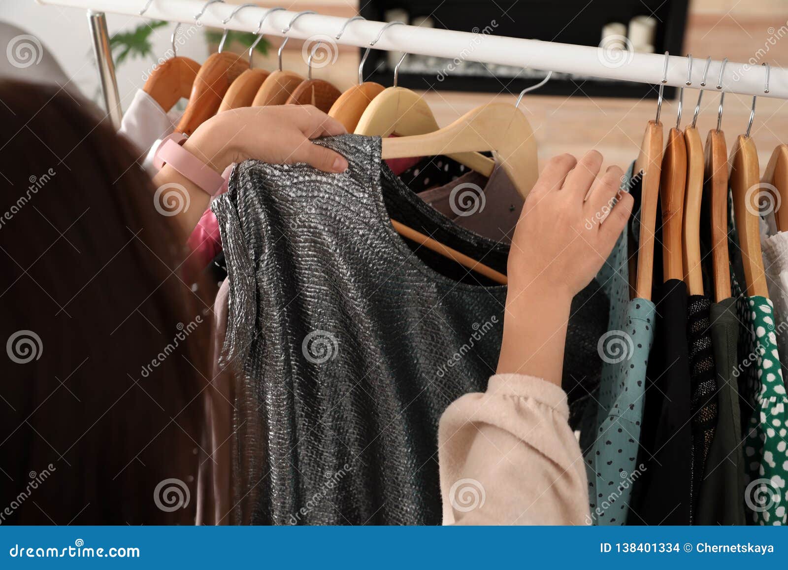 Woman Choosing Clothes from Wardrobe Rack Stock Photo - Image of dress ...