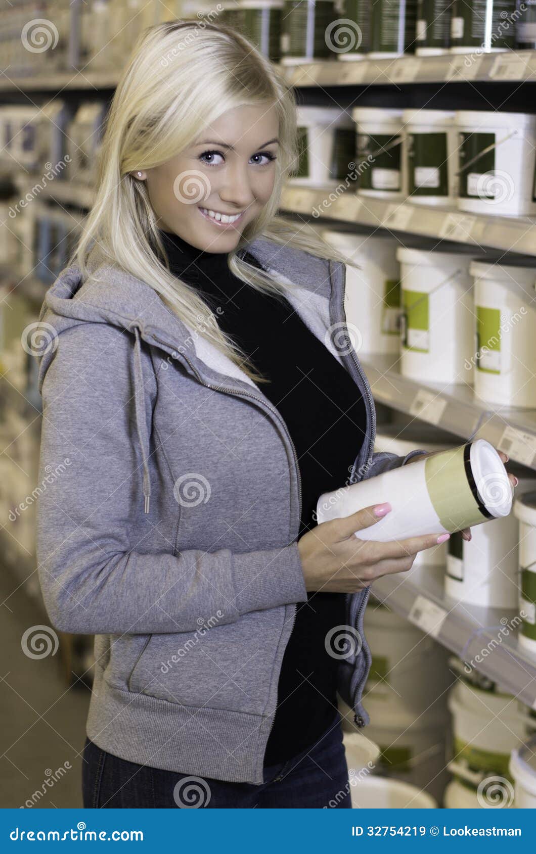 Woman Choosing between Products in Hardware Store Stock Image - Image ...