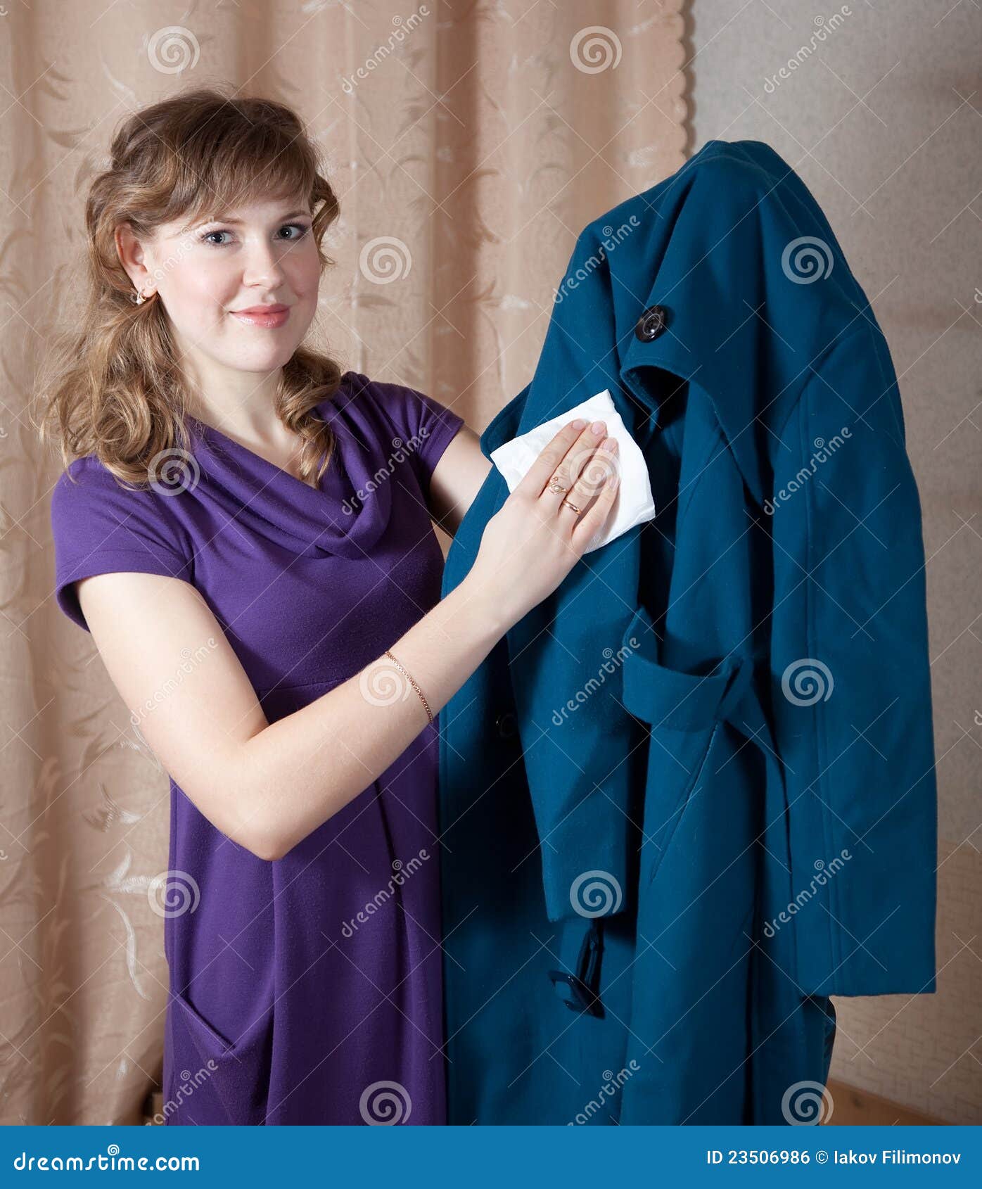 Woman cleaning coat stock photo. Image of topcoat, clothing - 23506986