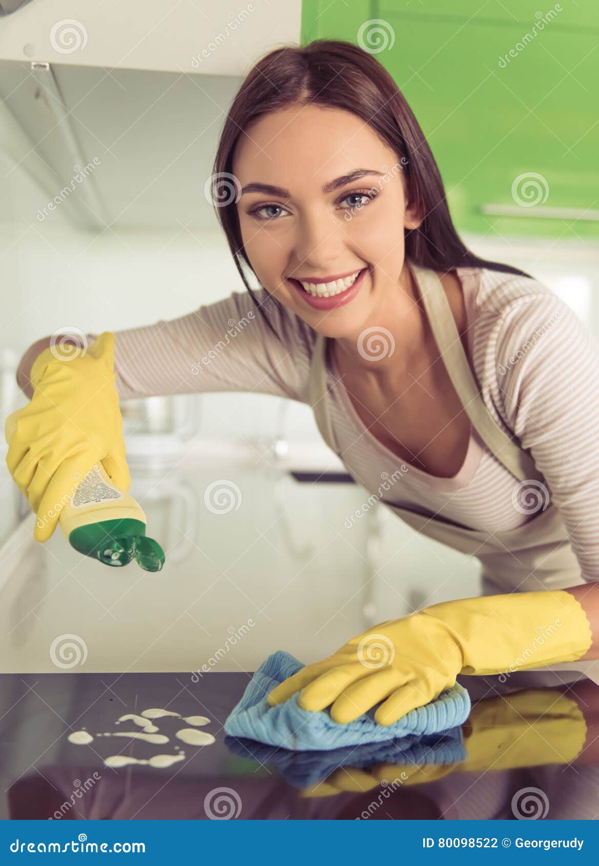 Woman cleaning her kitchen stock photo. Image of gloves - 80098522