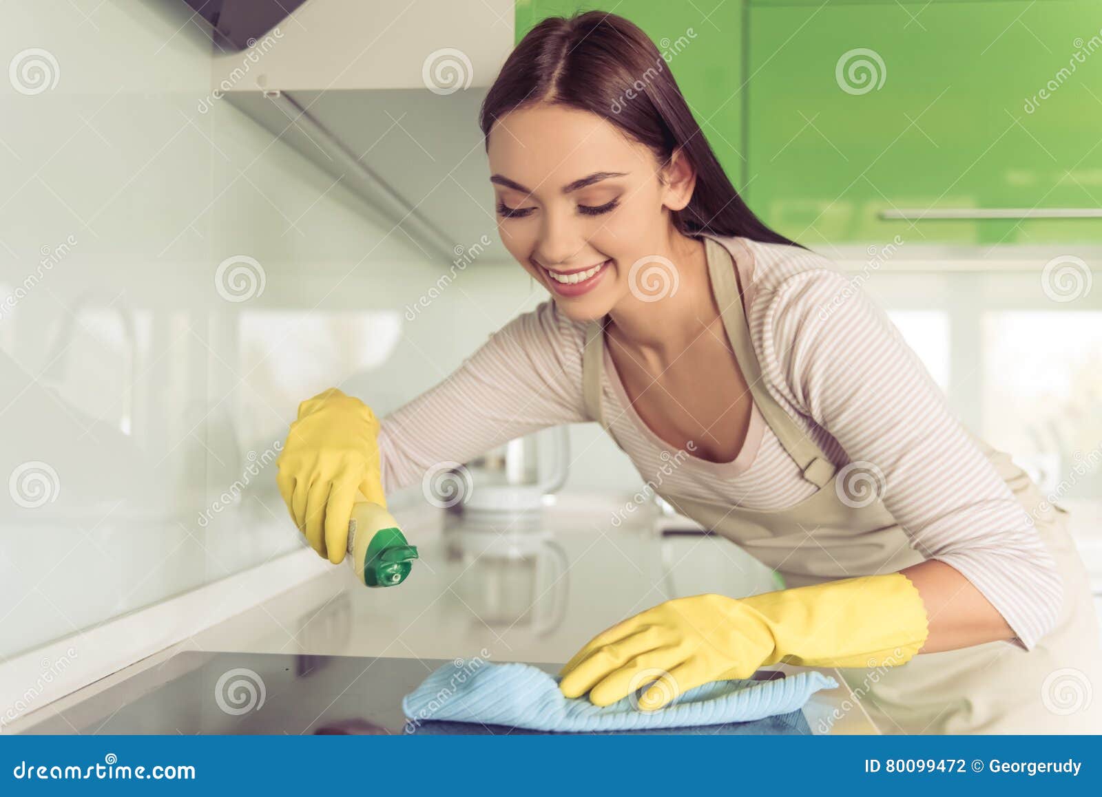 Woman cleaning her kitchen stock photo. Image of casual - 80099472