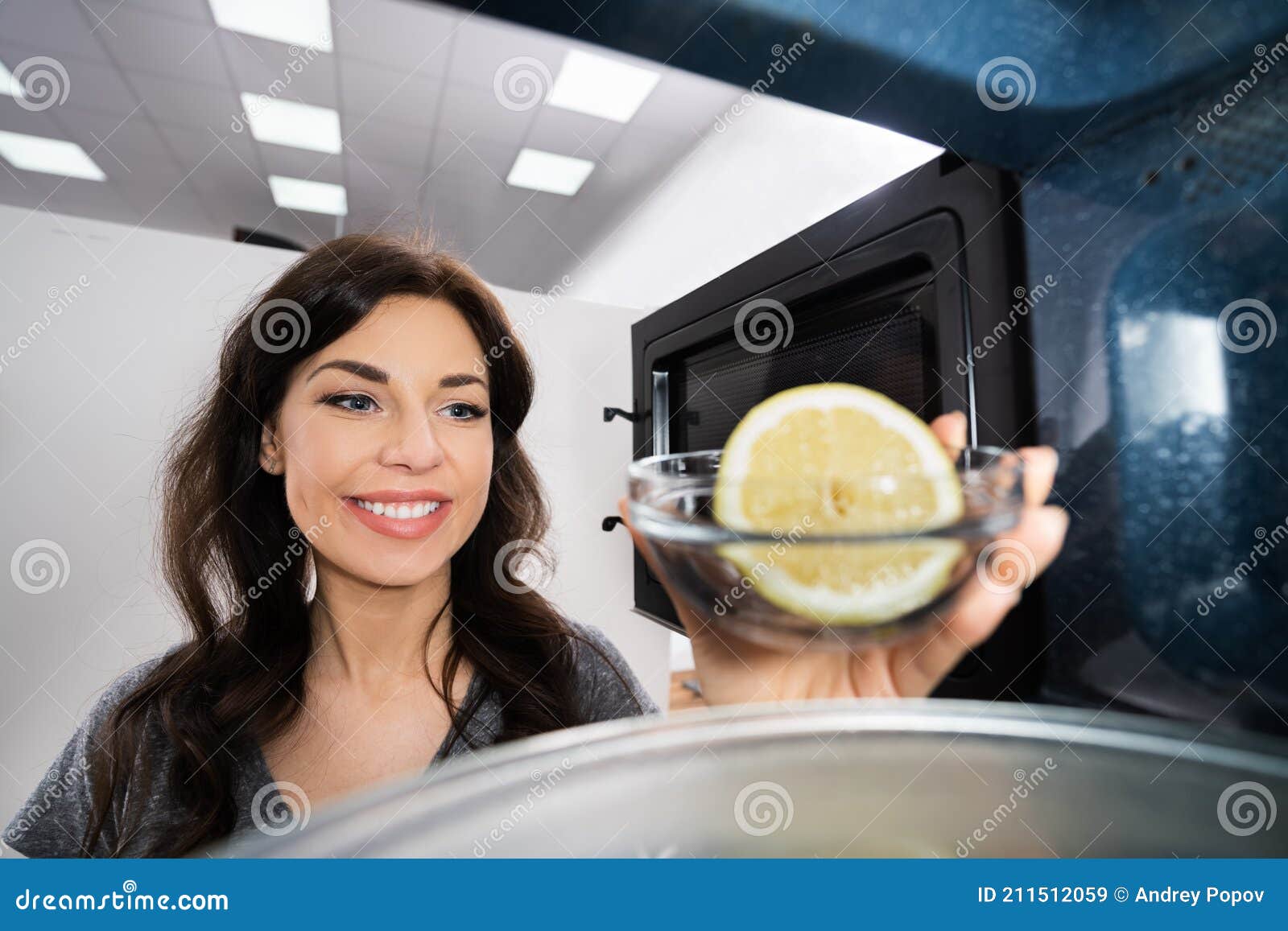 Woman Cleaning Microwave with Lemon Stock Image - Image of construction ...