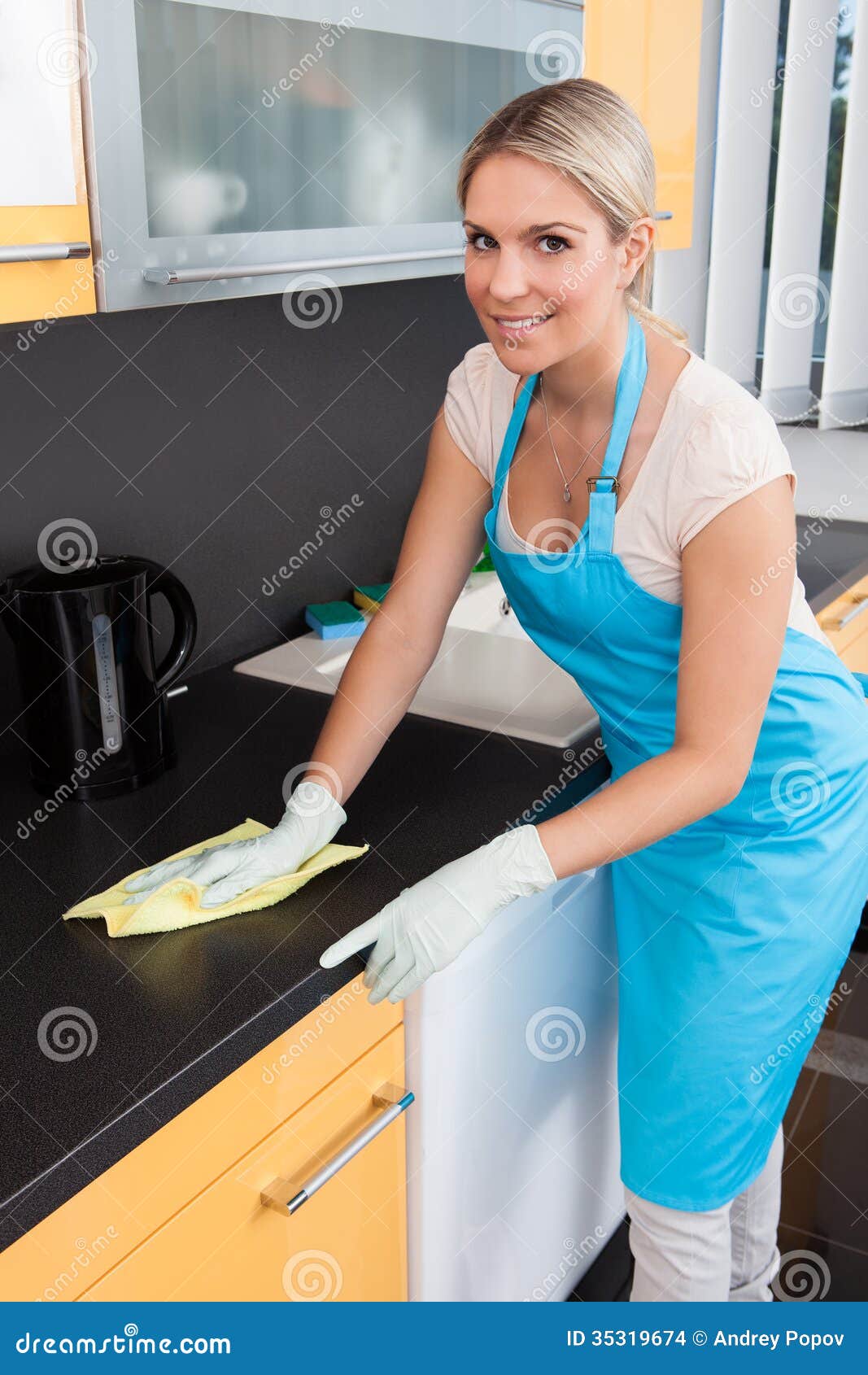 Woman Cleaning Worktop stock photo. Image of apron, indoors - 35319674