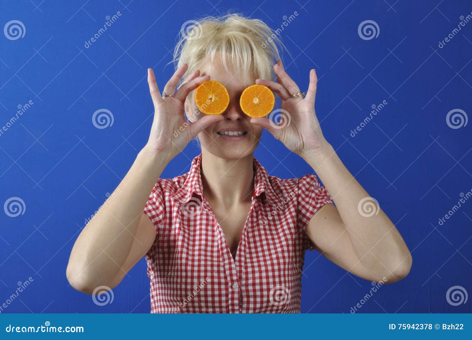 Woman with a clementine stock photo. Image of portrait - 75942378