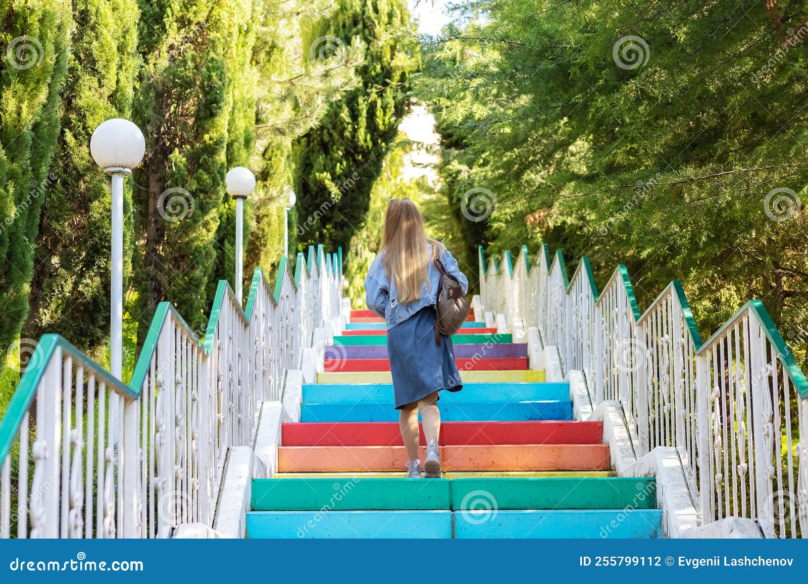 A Woman Climbs Up the Colored, Multi-colored Stairs. Concrete Colored ...