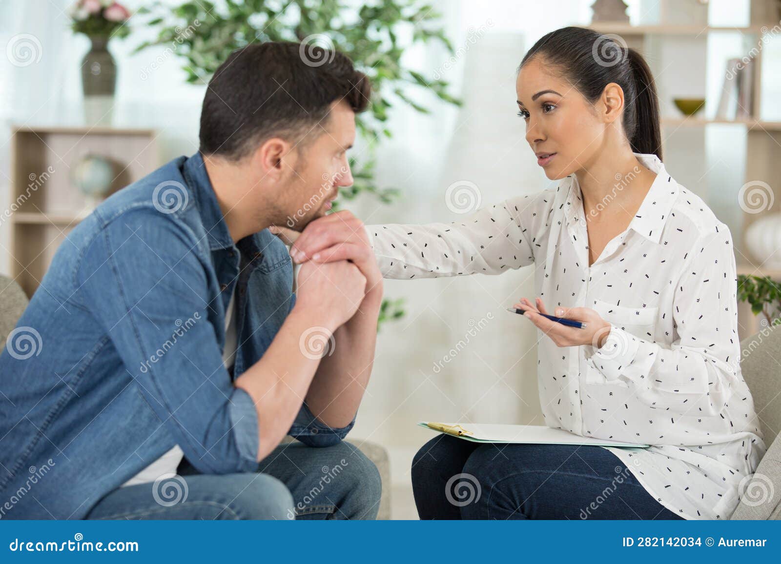 Woman with Clipboard Consoling Man Stock Photo - Image of console ...