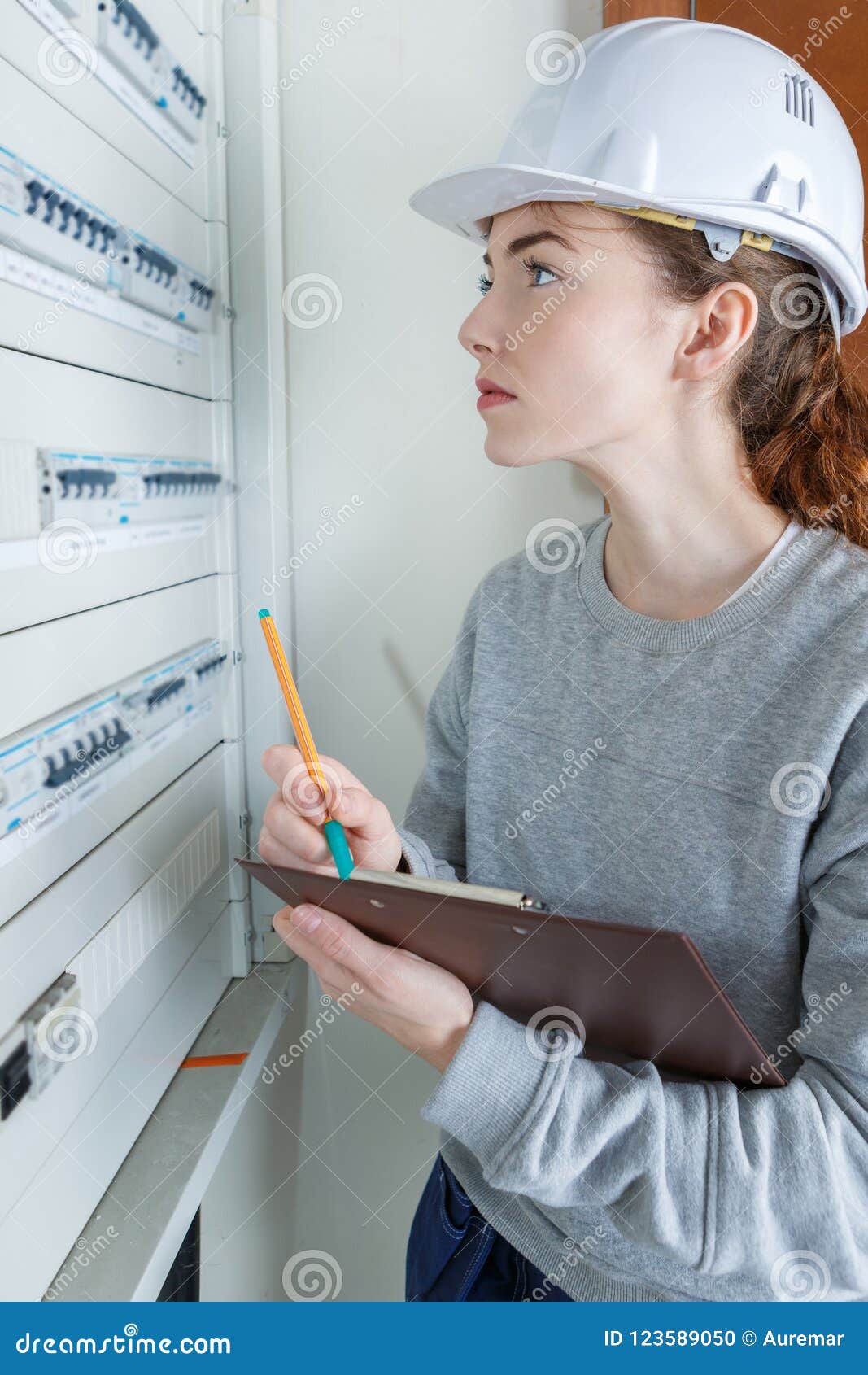 Woman with Clipboard Inspecting Electrical Box Stock Photo - Image of ...