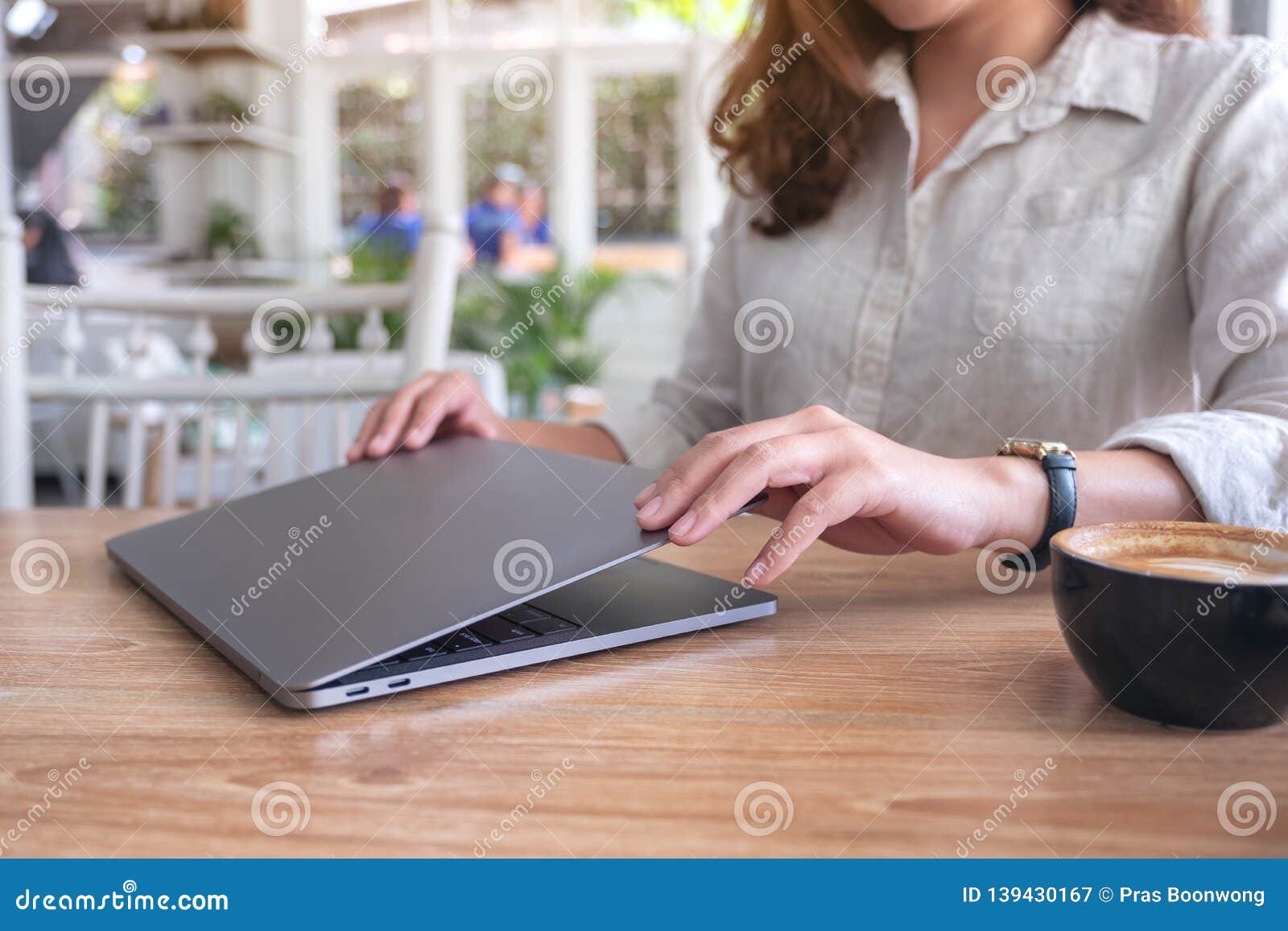 A Woman Close and Open a Laptop Computer on Table after Finished Using ...
