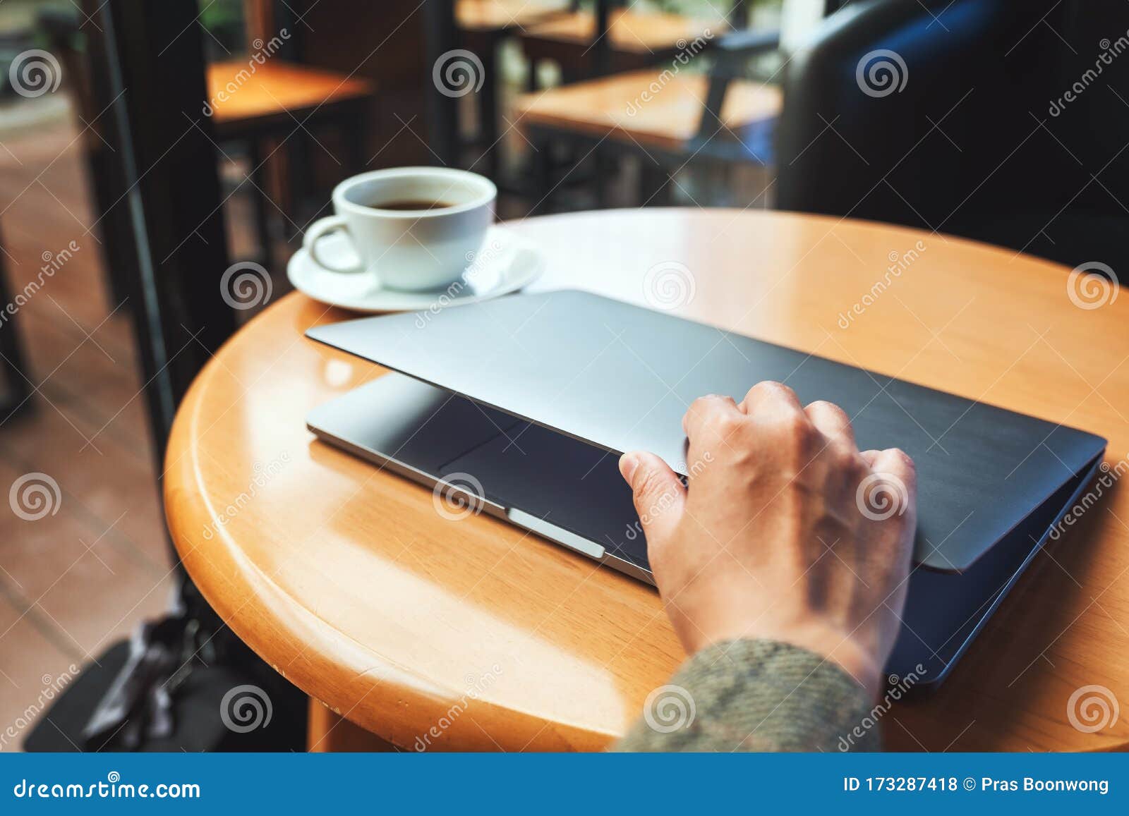 A Woman Close and Open a Laptop Computer on Table after Finished Using ...
