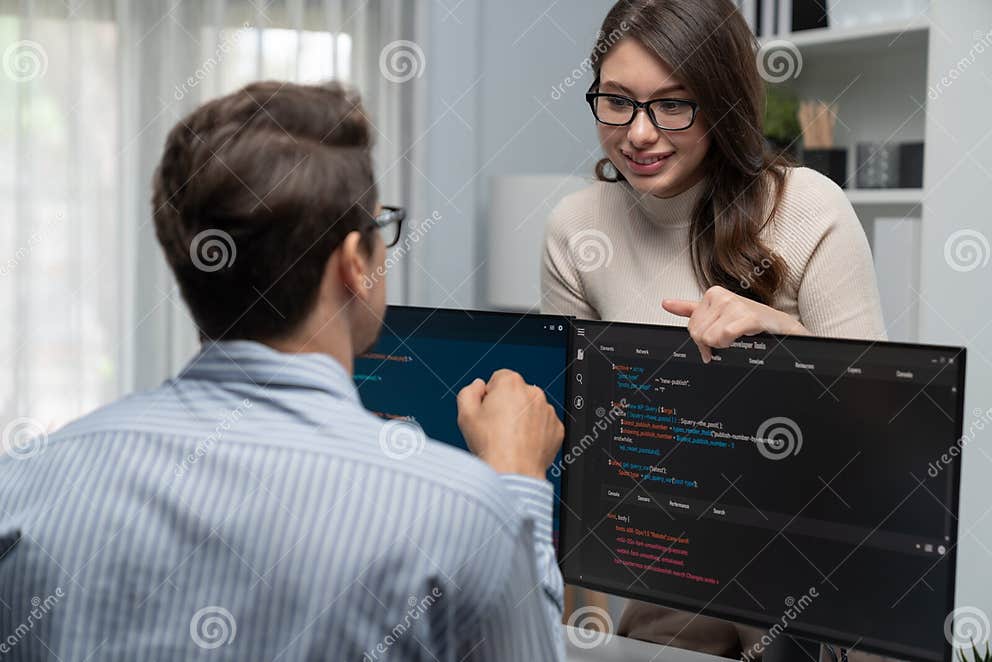 Woman Standing Opposite To Man Programmer Working on Desk To Discuss ...