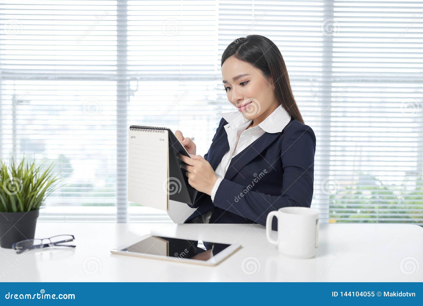 Woman on Computer Desk Writing on a Calendar Stock Image - Image of ...