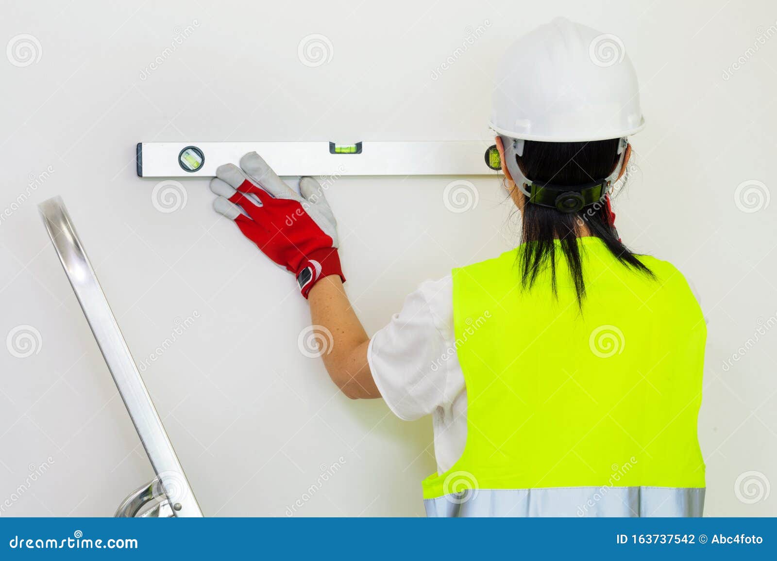 Woman Construction Worker Checking Wall Level Stock Photo - Image of ...
