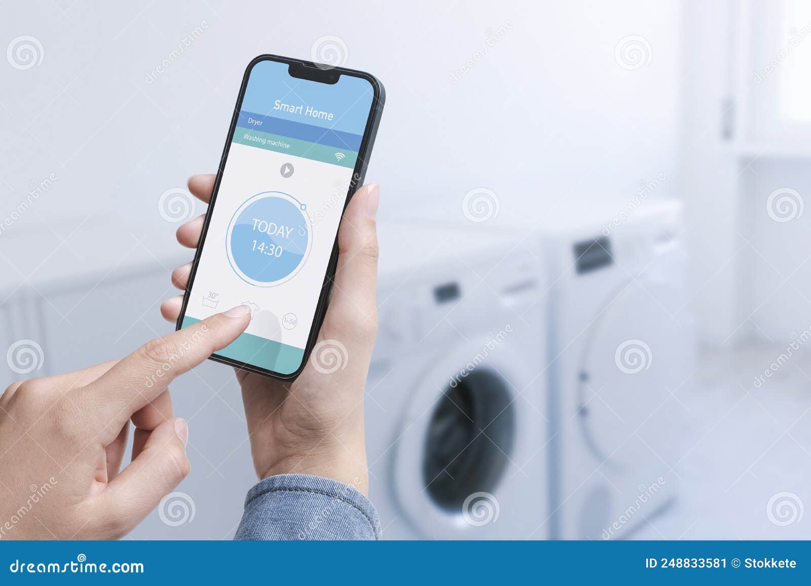 Woman Controlling Her Washing Machine from Her Phone Stock Image ...