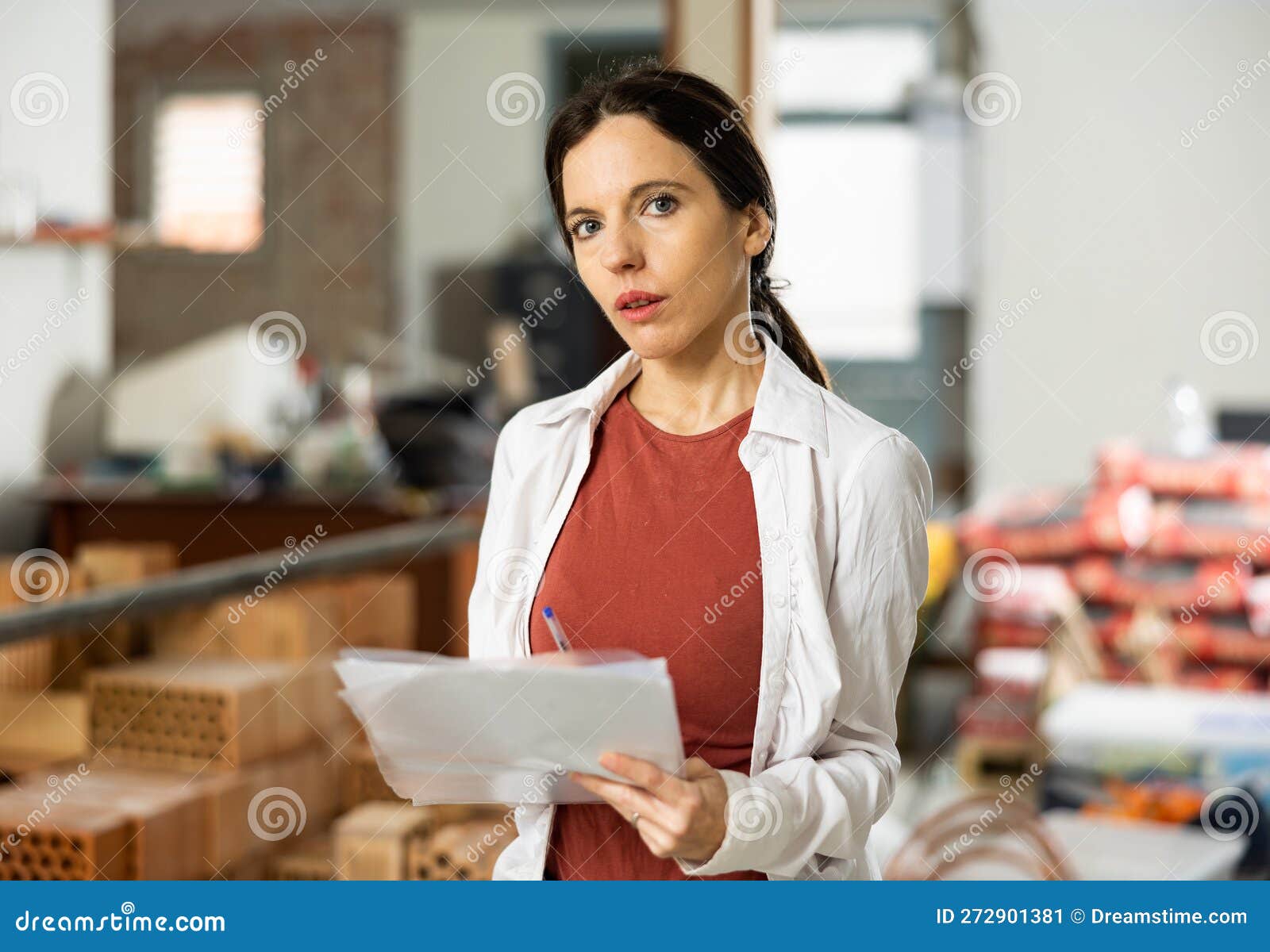 Woman Controls the Progress of Repair Work and Keeps Notes on Piece of ...