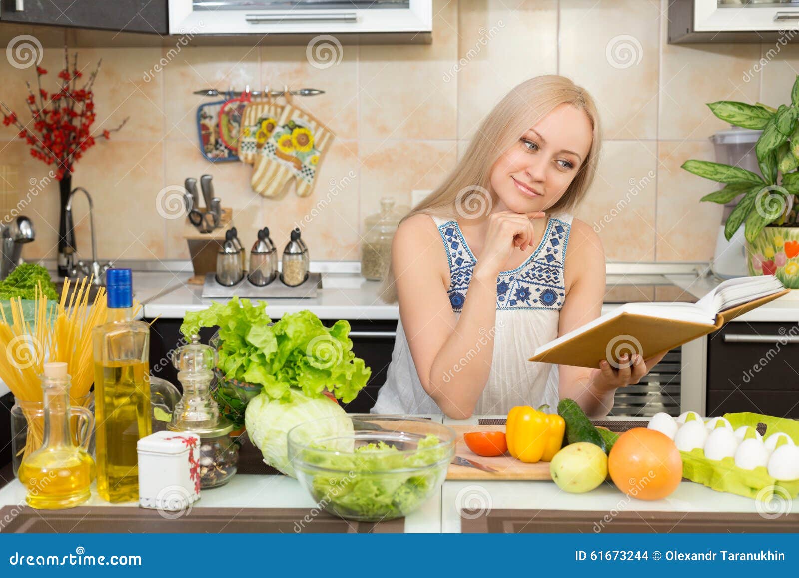 Woman with Cooking Book Sitting at the Kitchen Table Stock Photo ...