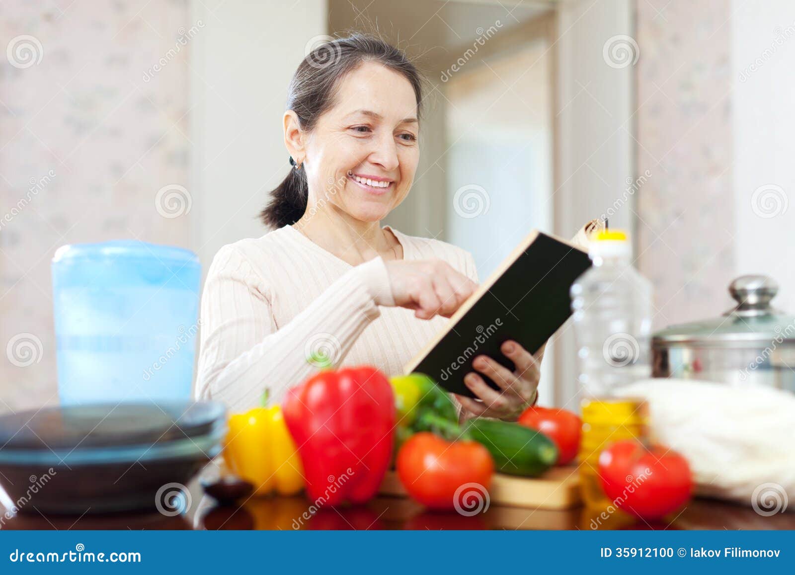 Woman Cooking with Cookbook in the Kitchen Stock Photo - Image of home ...