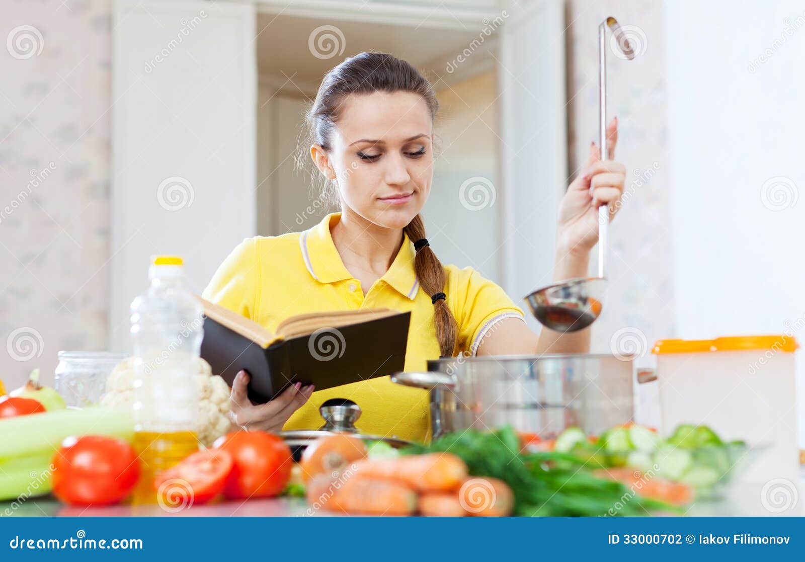 Woman Cooking Food with Book Stock Photo - Image of cook, book: 33000702