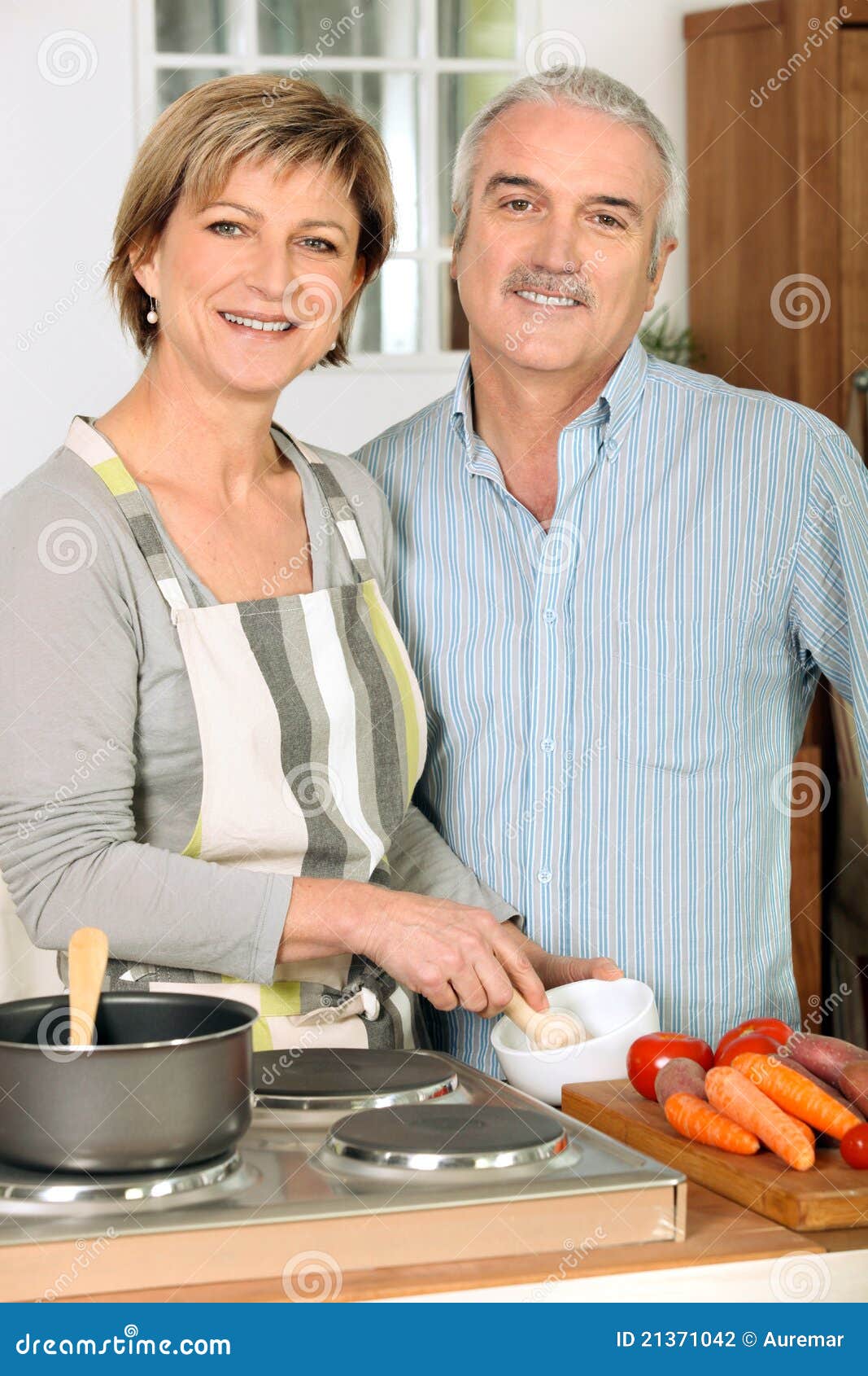 A Woman Cooking with Her Husband Stock Photo - Image of range, portrait ...