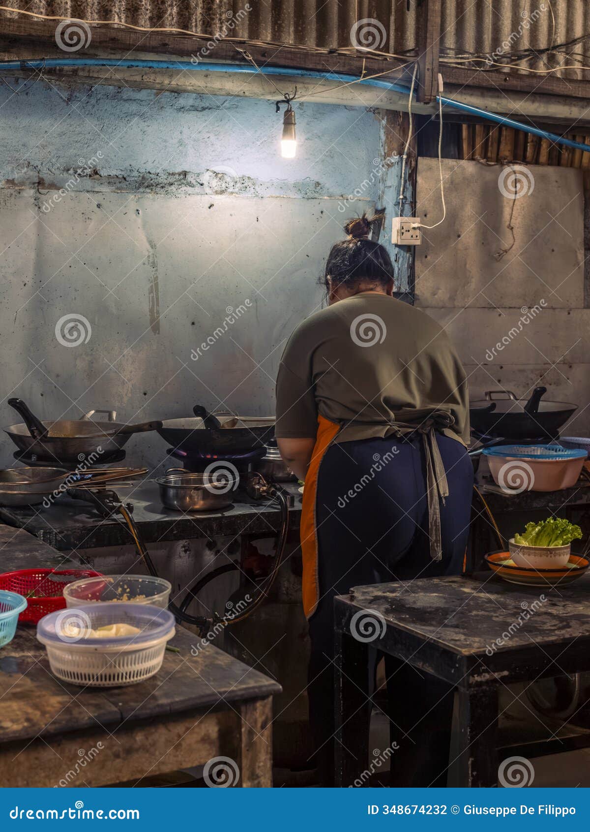 A Woman Cooking Inside the Basic Kitchen of a Restaurant in Kep in ...