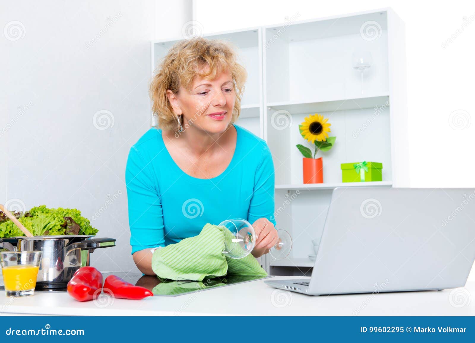 Woman Cooking in the Kitchen and Using Computer Stock Image - Image of ...