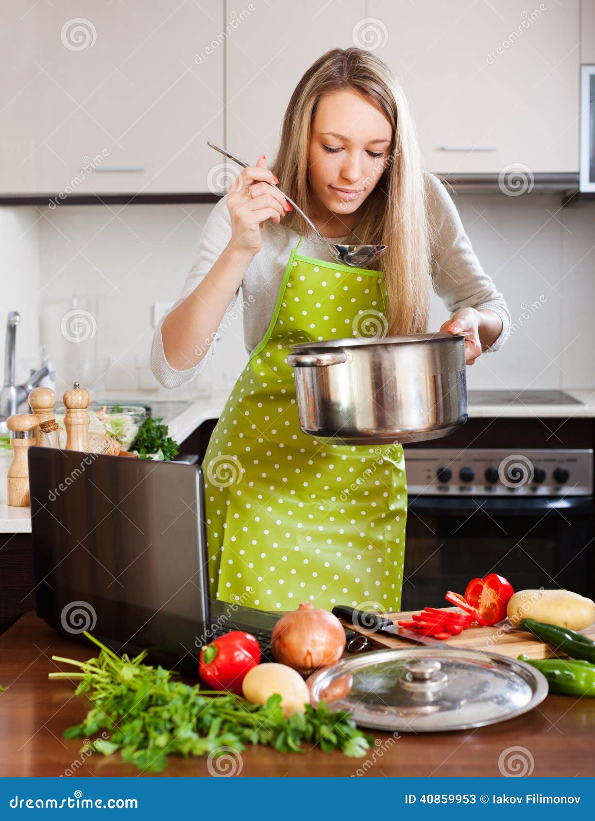 Woman Cooking Soup with Laptop Stock Image - Image of smiling, ladle ...
