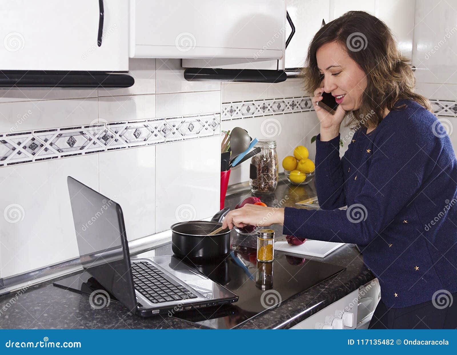 Cooking and using a laptop stock photo. Image of eating - 117135482