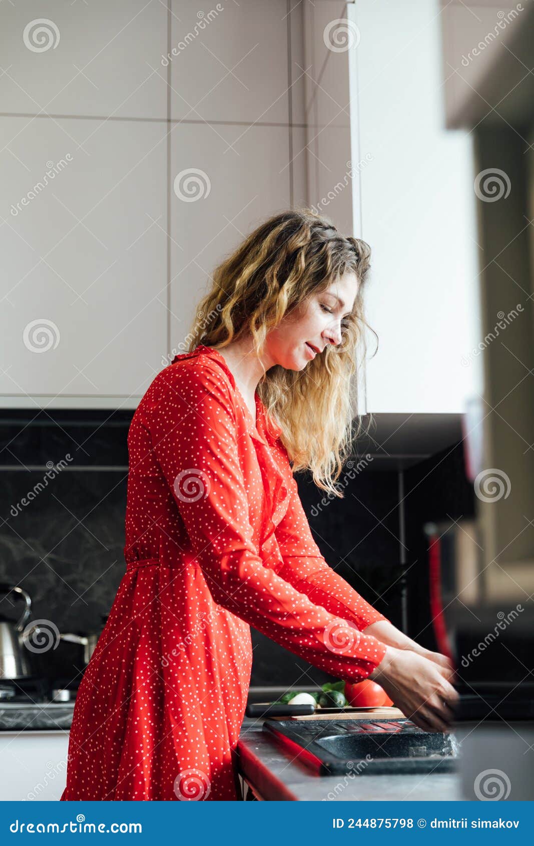 Beautiful Woman Cooks in the Kitchen Peeling Vegetables Stock Photo ...
