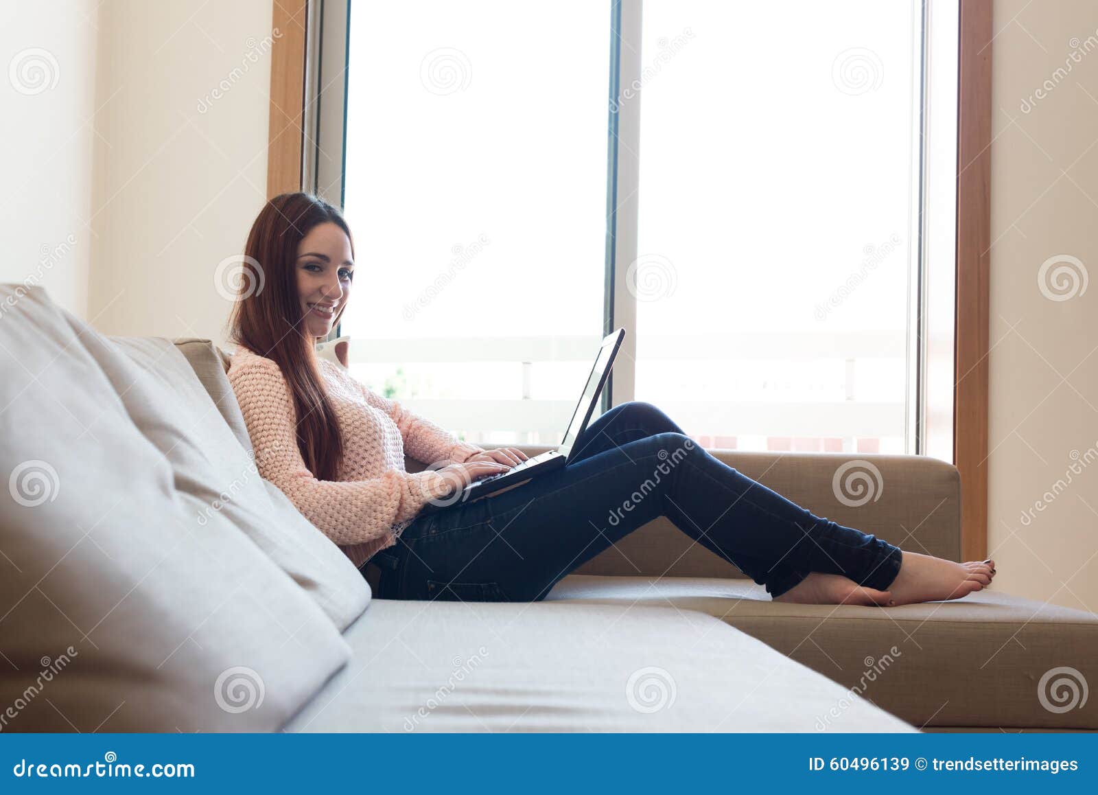 Woman on couch with laptop stock image. Image of lifestyle - 60496139