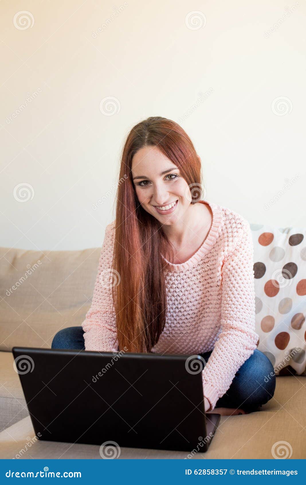 Woman on couch with laptop stock image. Image of electronic - 62858357