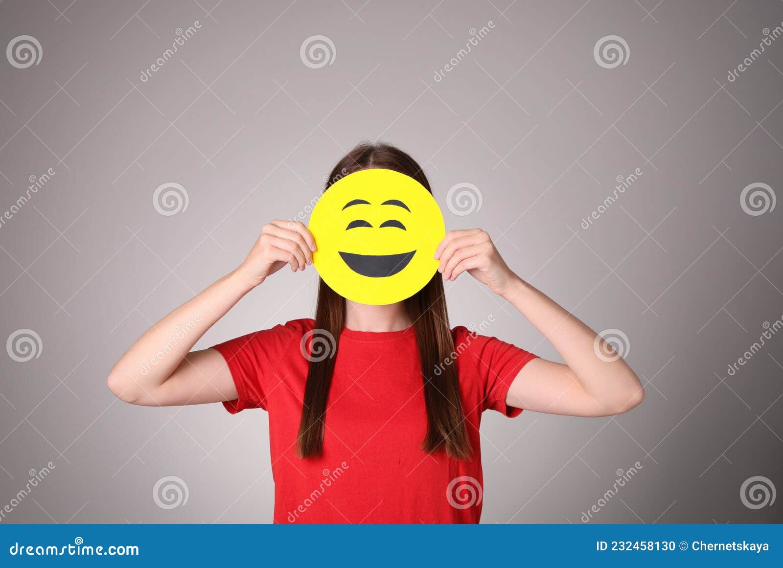 Woman Covering Face with Laughing Emoji on Grey Background Stock Photo ... Woman Covering Face with Laughing Emoji on Grey Background Stock Photo ...