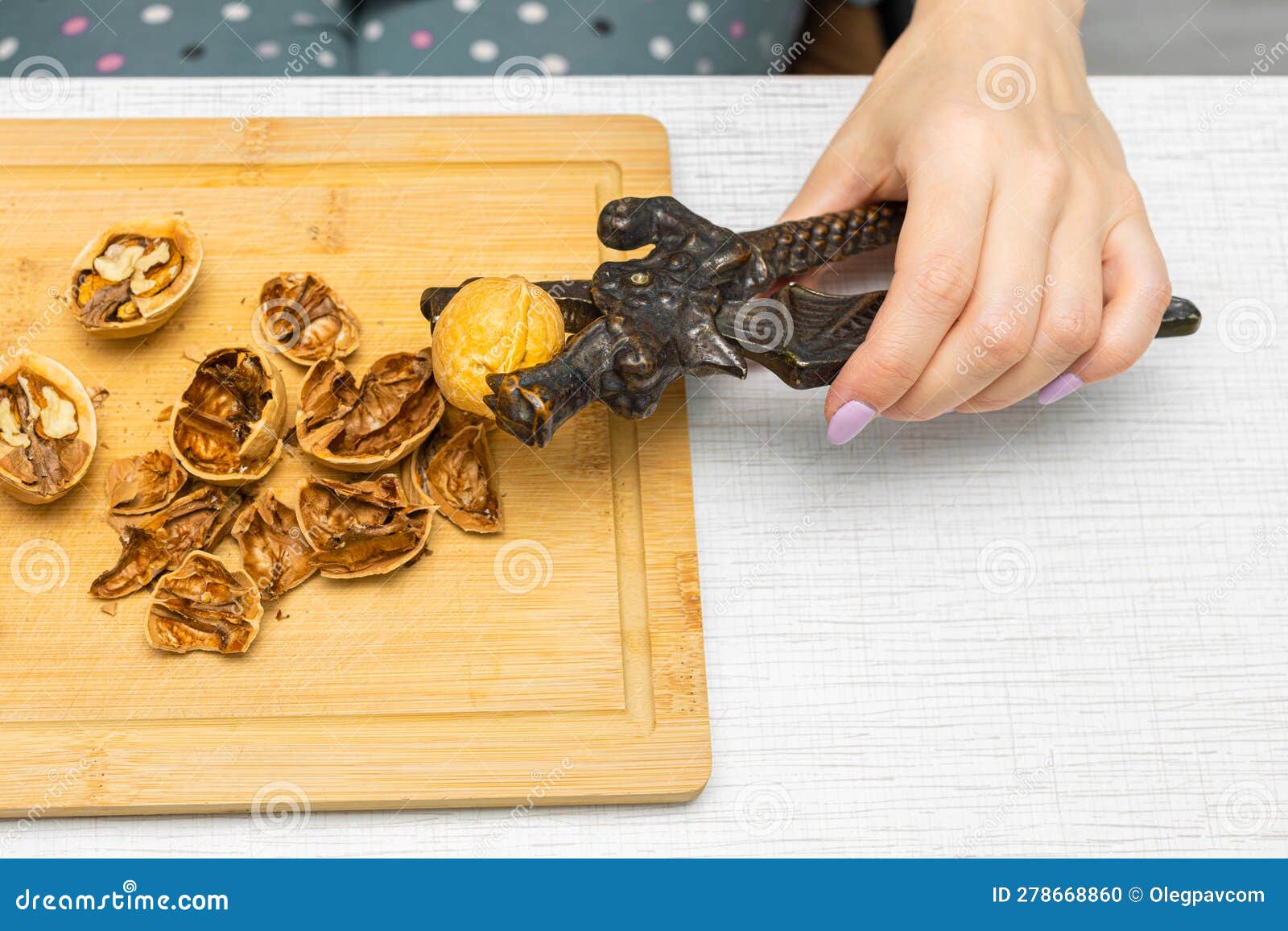 Woman Cracking Walnuts with a Hand-held Nutcracker. Stock Photo - Image ...