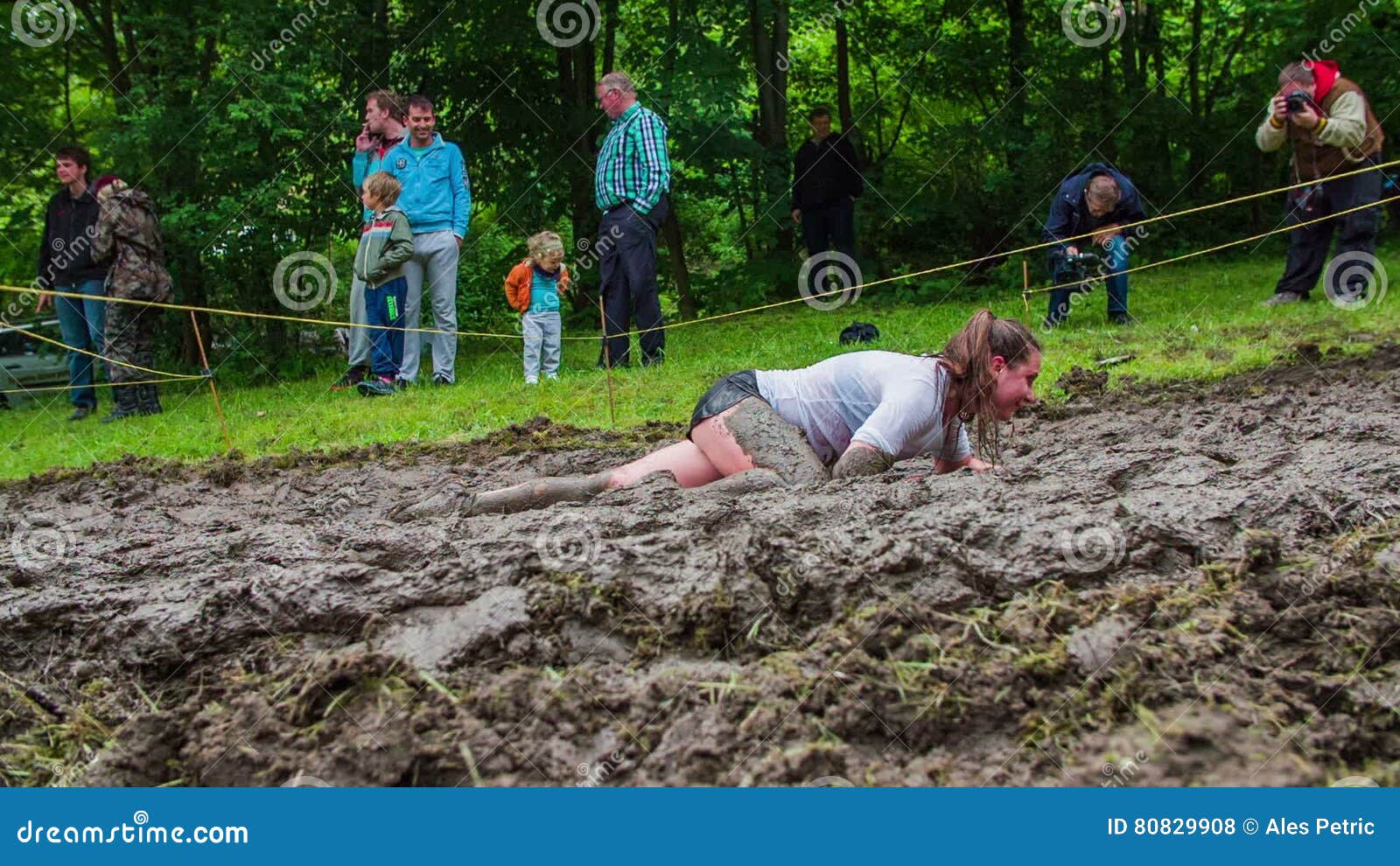 Woman Crawling through Mud As Part of Obstacle Course Stock Footage ...