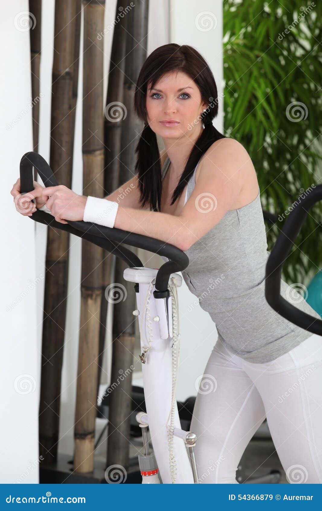 Woman on cross trainer stock image. Image of caucasian - 54366879