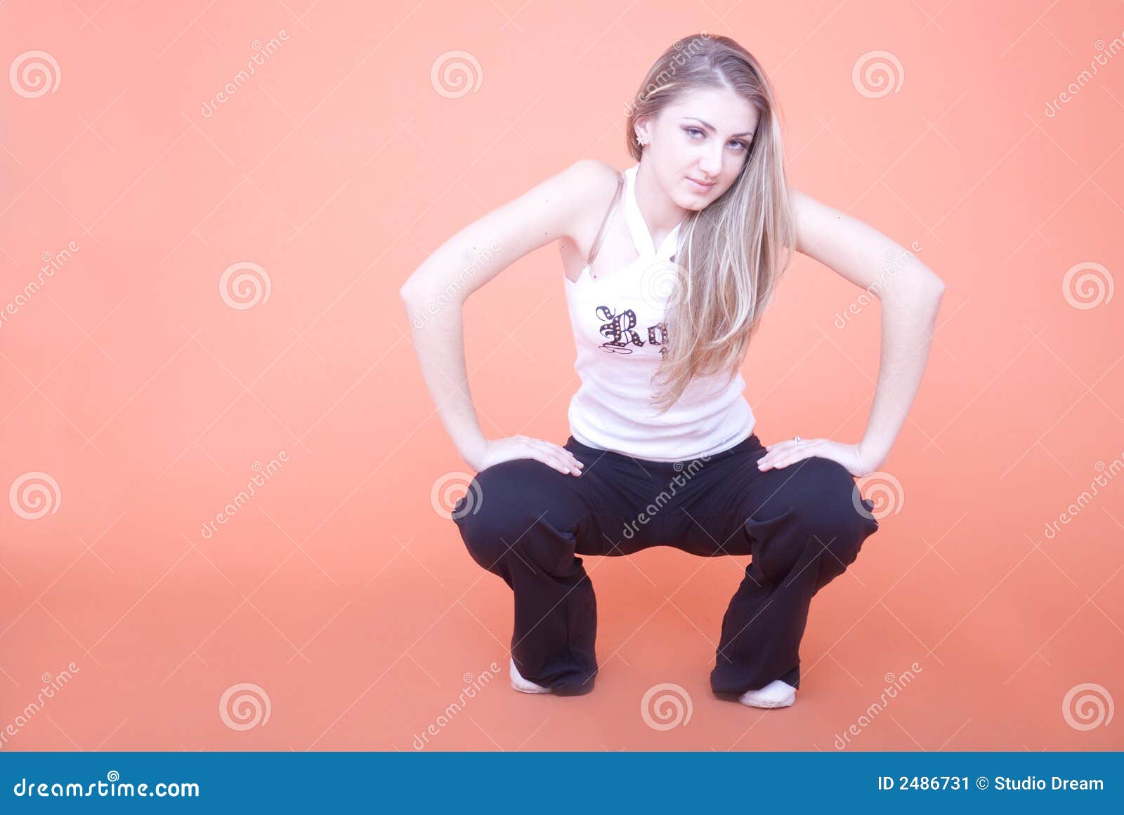 Woman Crouching By Bookshelf In Library Royalty-Free Stock Image ...