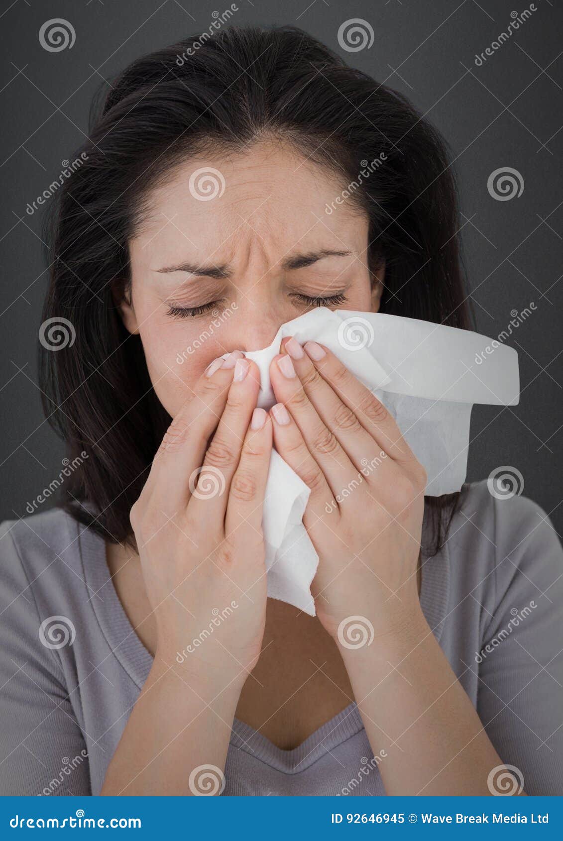Woman Crying into Tissue Against Grey Wall Stock Image - Image of ...
