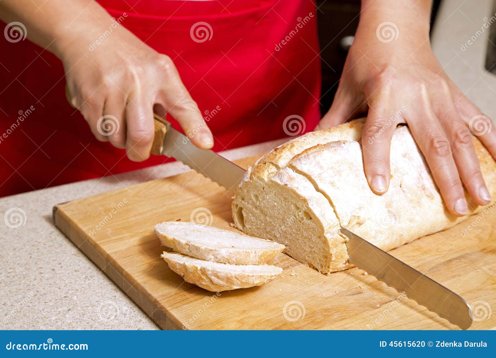 Woman cutting bread stock photo. Image of baker, baguette - 45615620