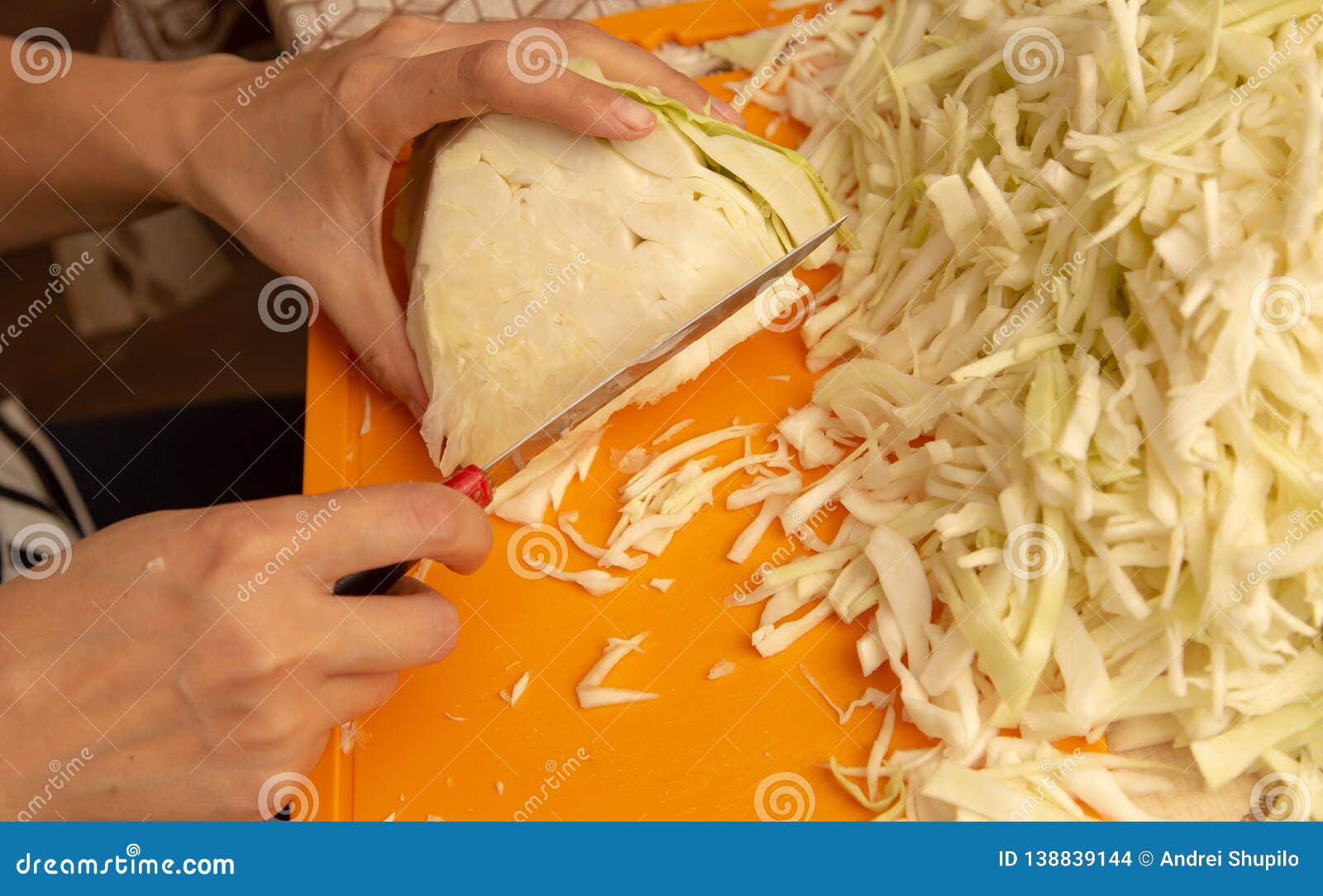Woman Cutting Cabbage with a Knife in the Kitchen Stock Photo - Image ...