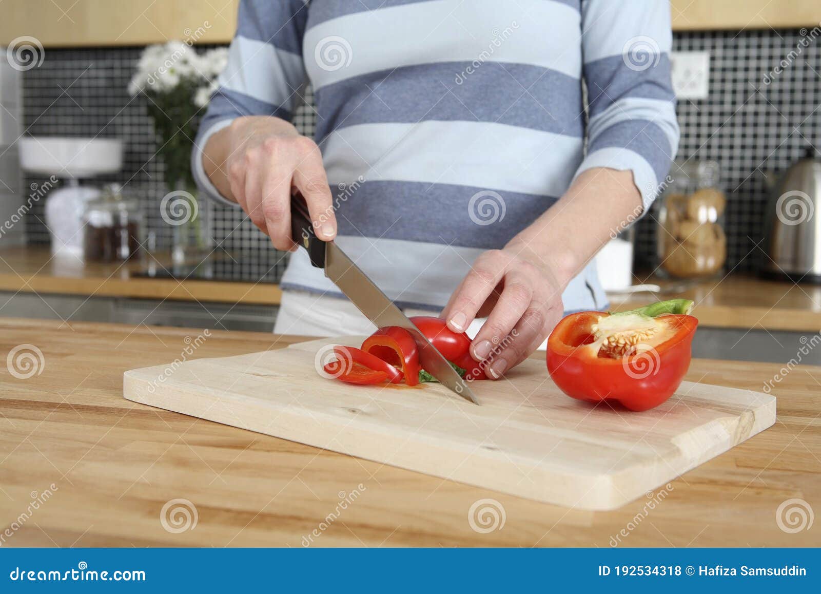 Woman Cutting Capsicum in the Kitchen. Conceptual Image Stock Photo ...