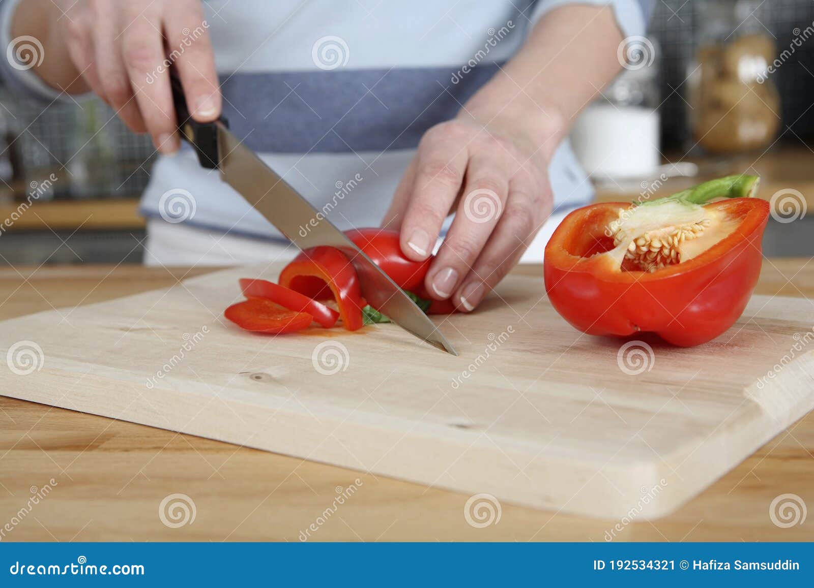 Woman Cutting Capsicum in the Kitchen. Conceptual Image Stock Image ...