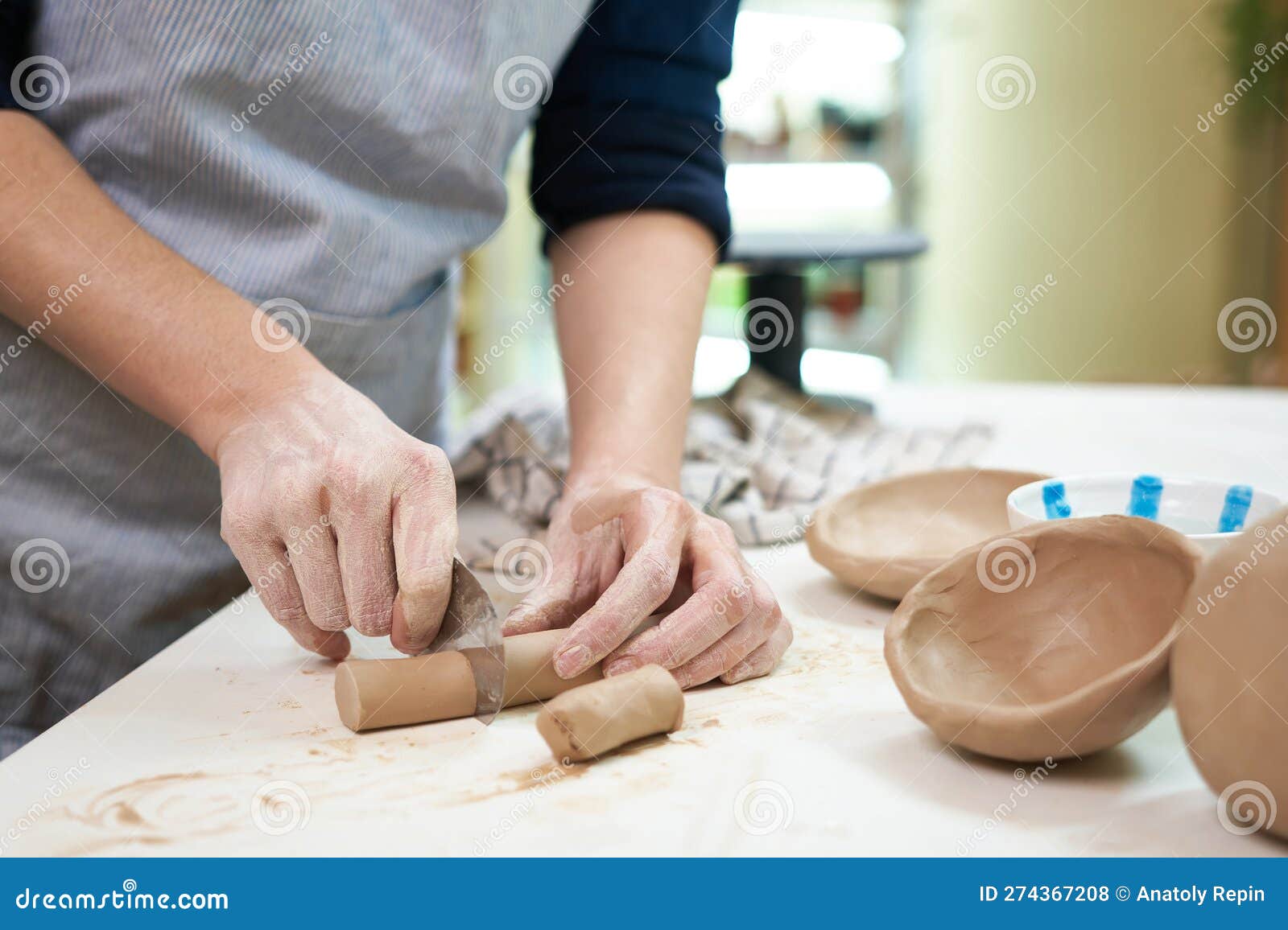 Woman Cutting Clay with Blade Standing Behind Table in Studio Stock ...