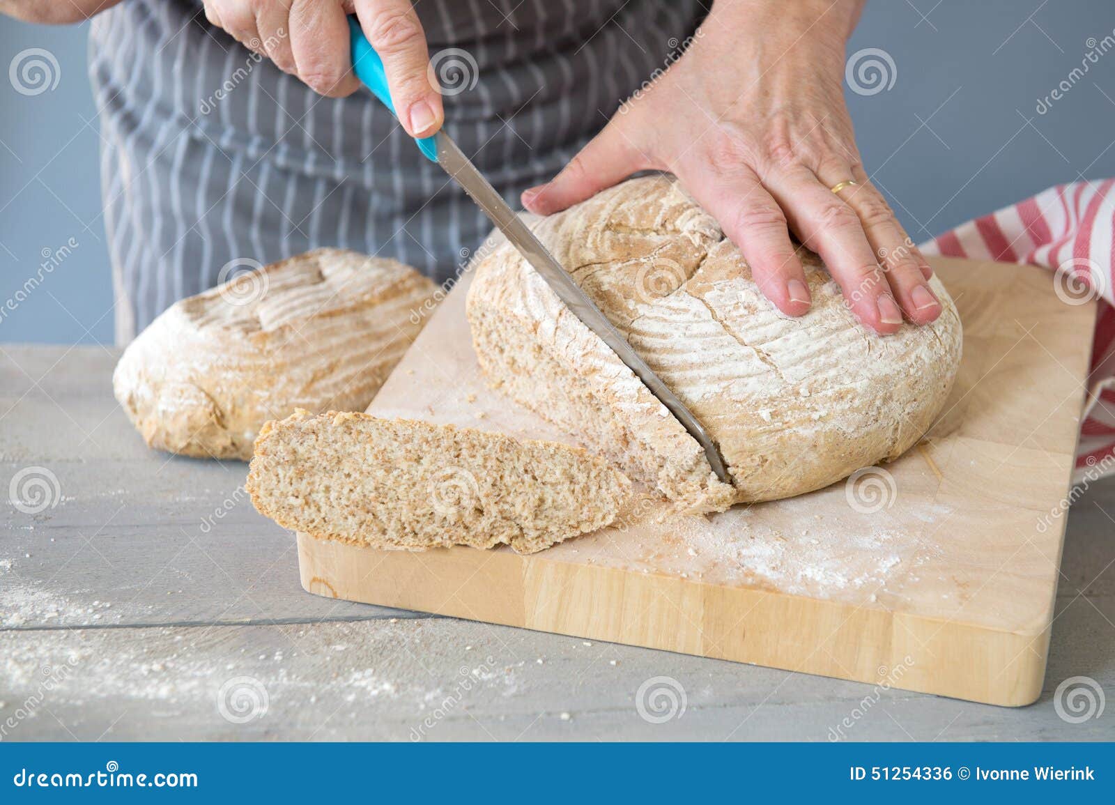 Woman Cutting Fresh Baked Bread Stock Photo - Image of baking, rising ...
