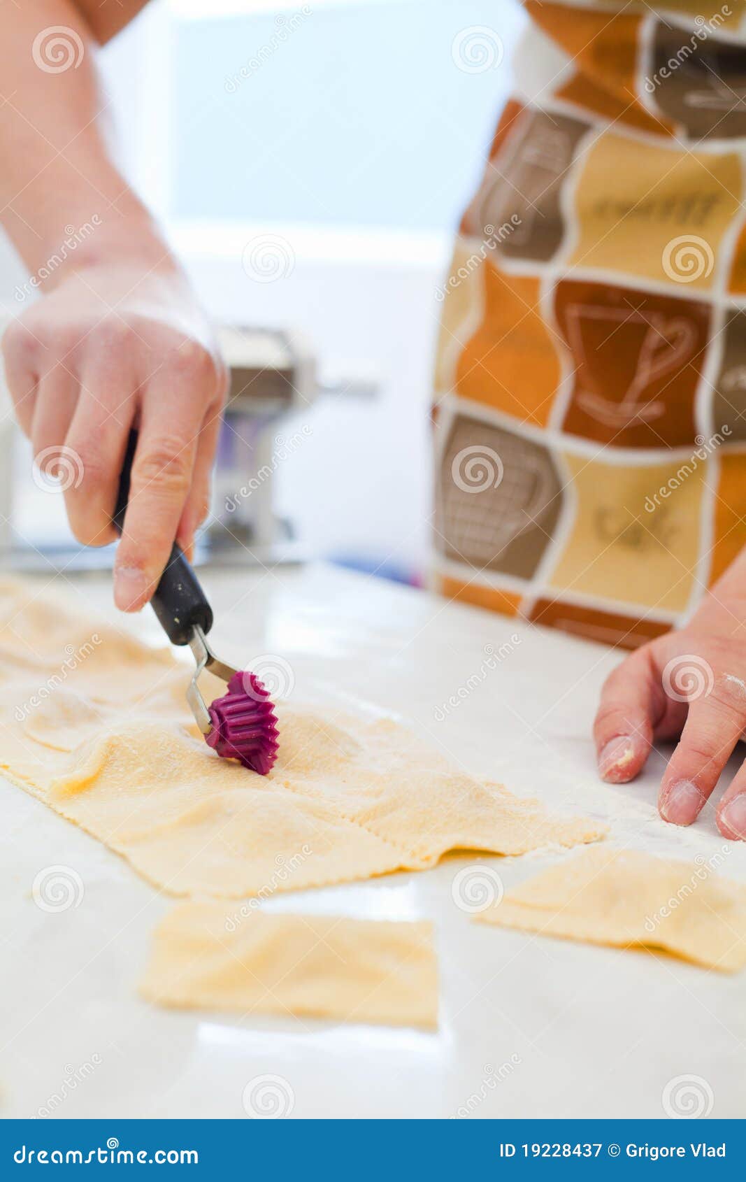 Woman cutting ravioli stock image. Image of tortellini - 19228437