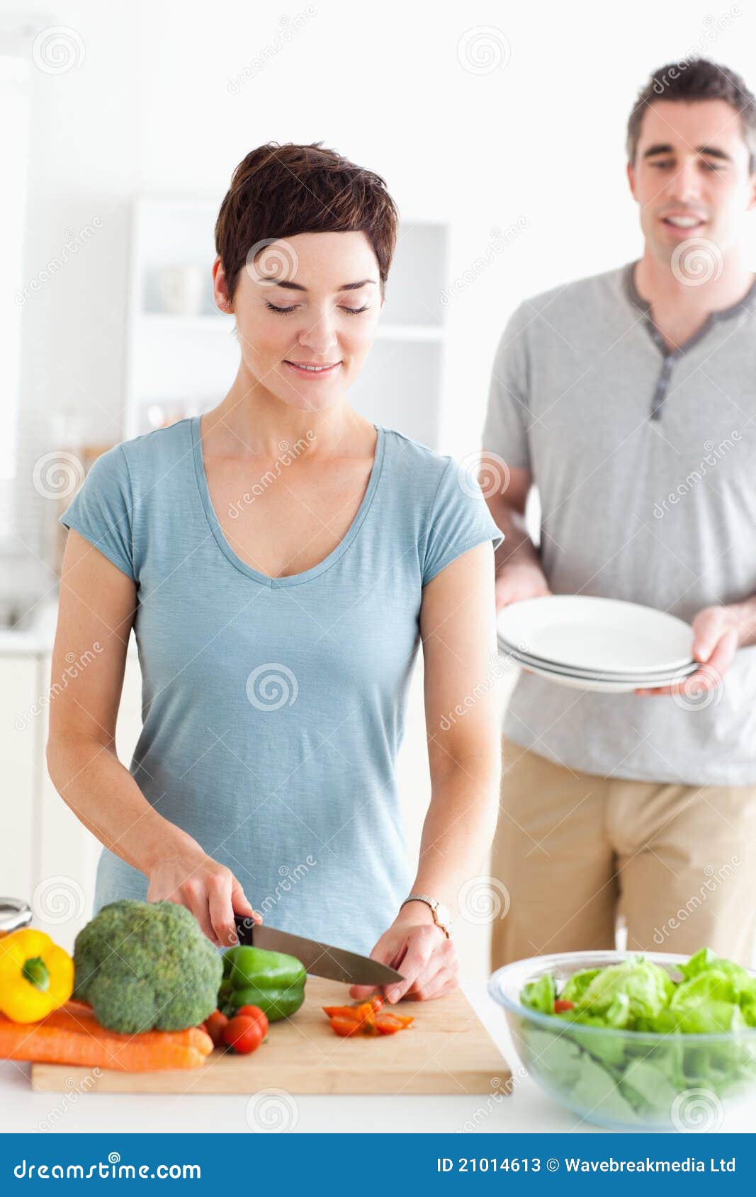 Woman Cutting Vegetables and Man Holding Plates Stock Image - Image of ...