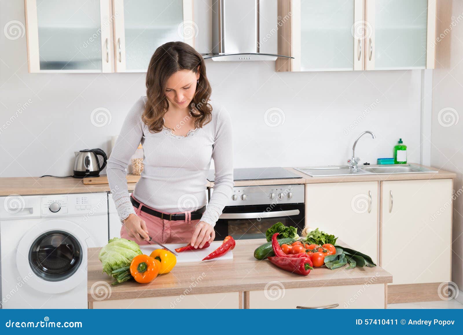 Woman cutting vegetables stock image. Image of home, nutrition - 57410411