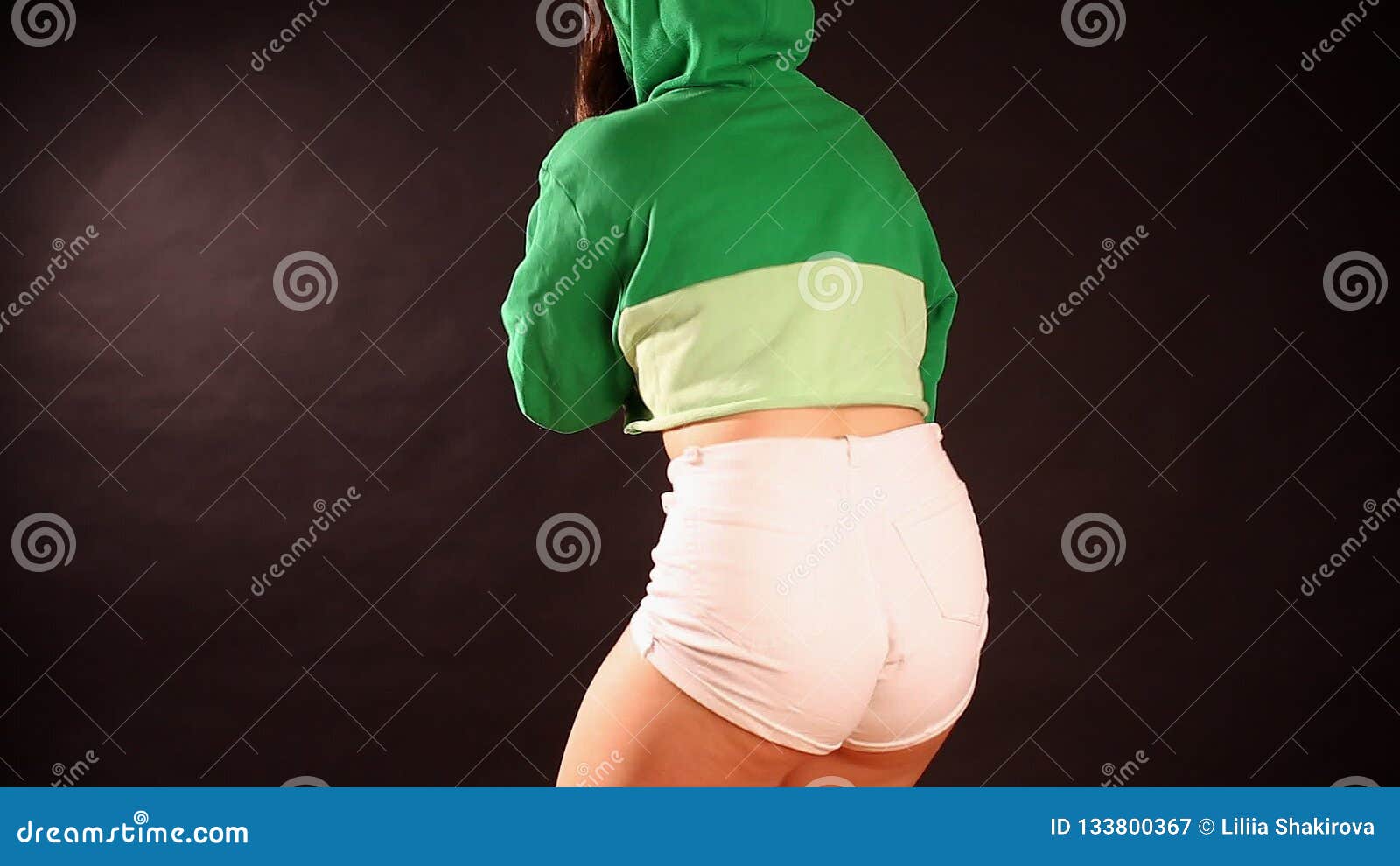 Woman Dancing Booty Twerk Sitting On The Floor On A Blue Background