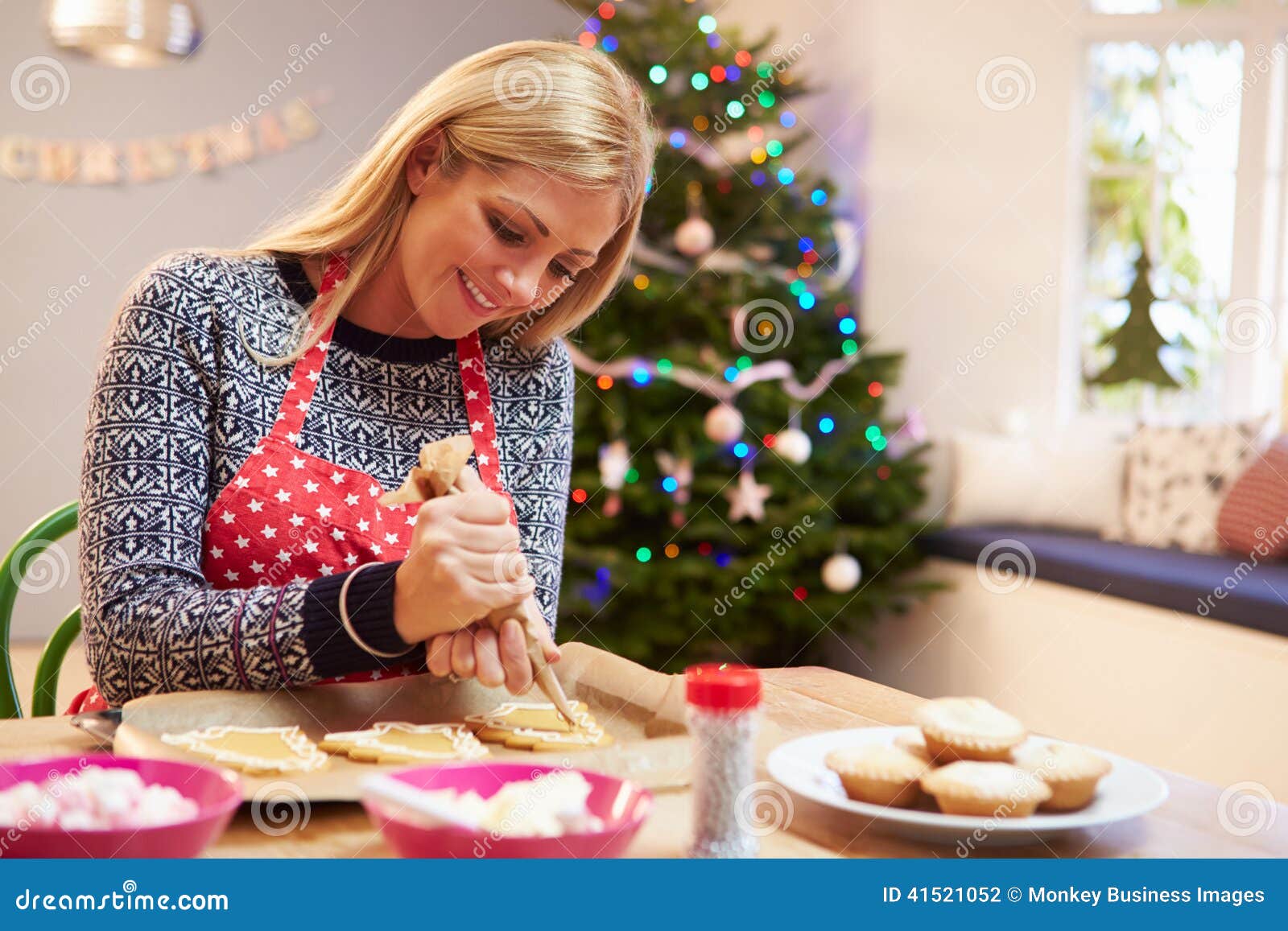 Woman Decorating Christmas Cookies in Kitchen Stock Photo - Image of ...