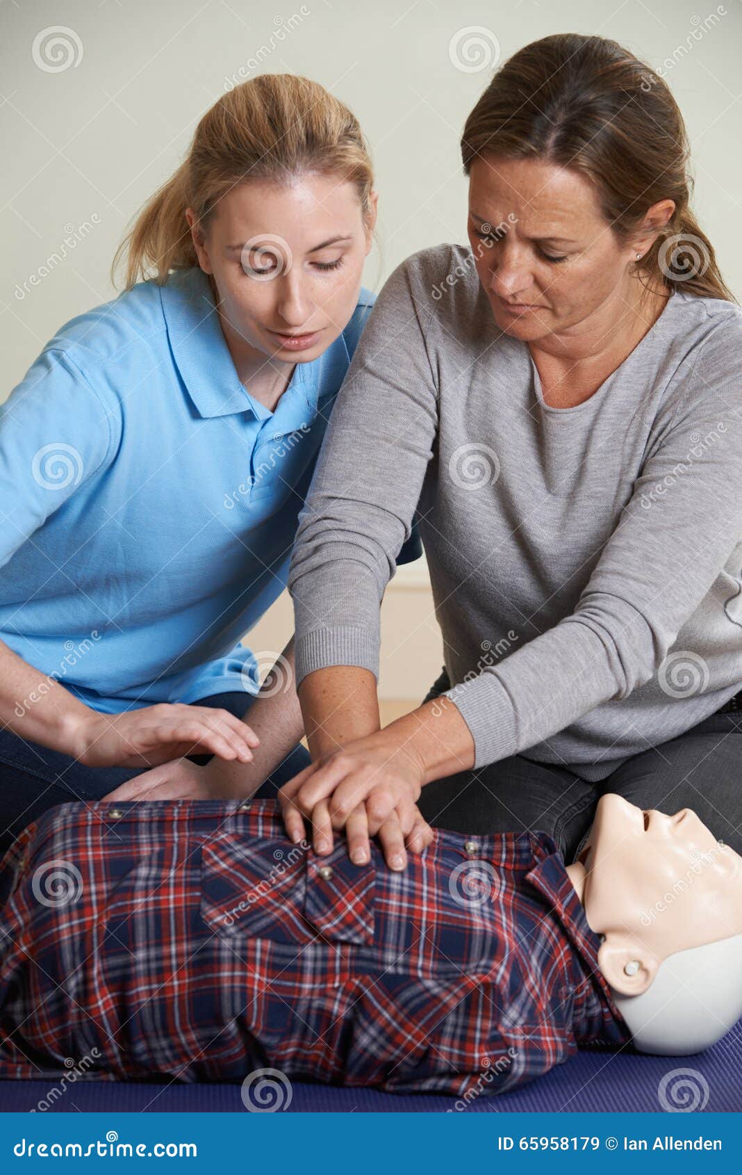 Woman Demonstrating CPR on Training Dummy in First Aid Class Stock ...
