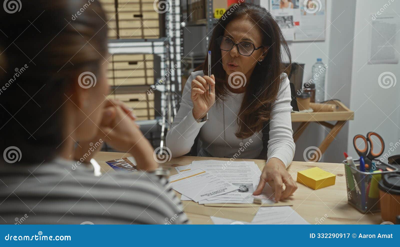 A Woman Detective Interrogates a Suspect at an Indoor Office with ...