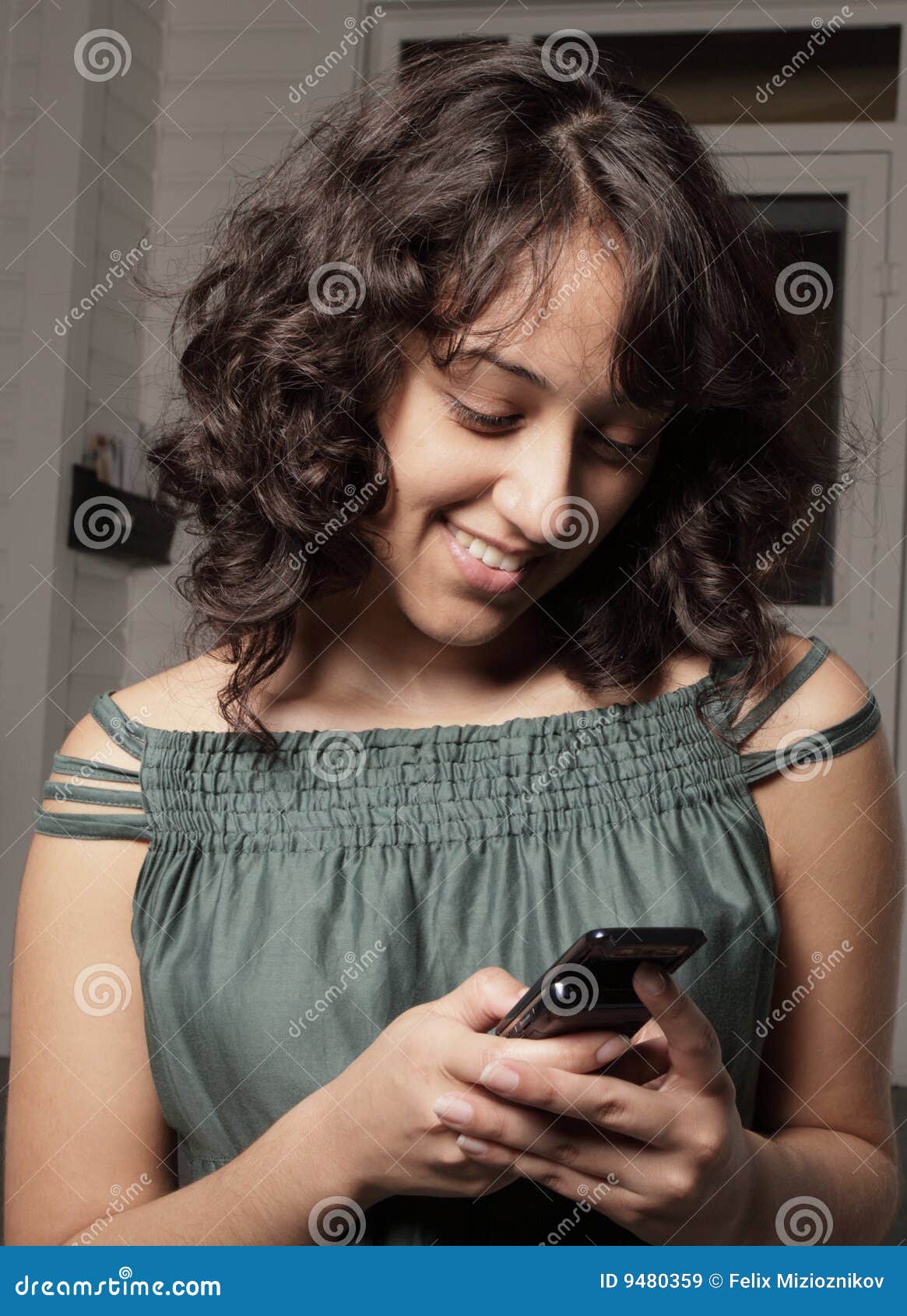 Woman dialing with a smile stock image. Image of brunette - 9480359