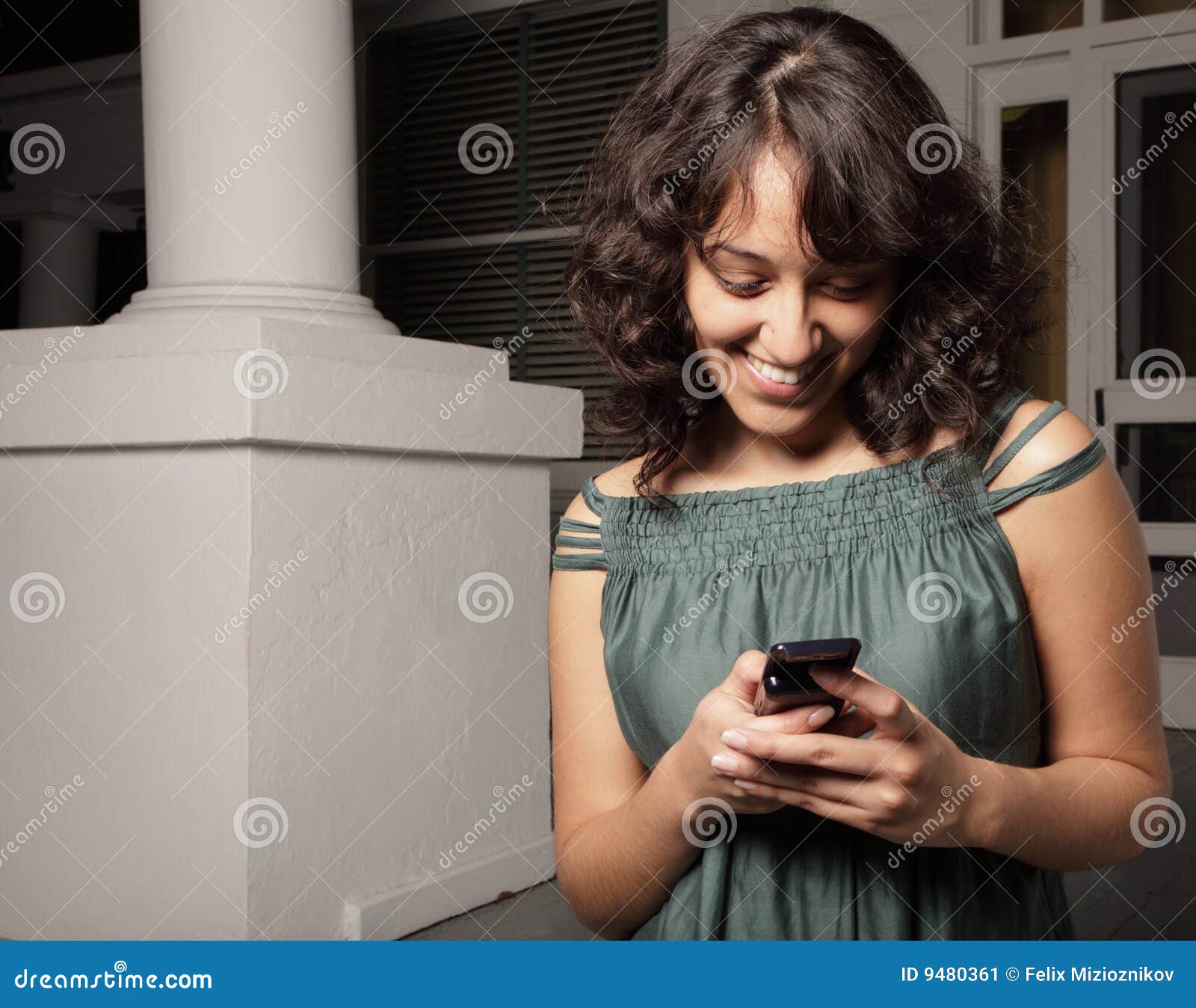 Woman dialing with a smile stock image. Image of brunette - 9480361